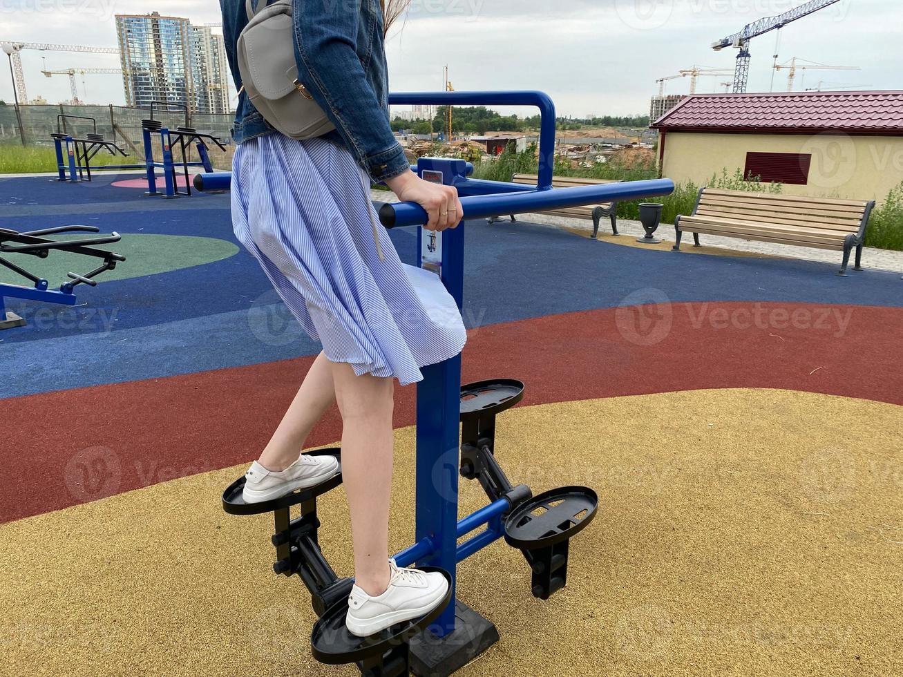 A Woman Goes In For Sports On A New Modern Blue Fitness Leg Trainer For Walking And Running On