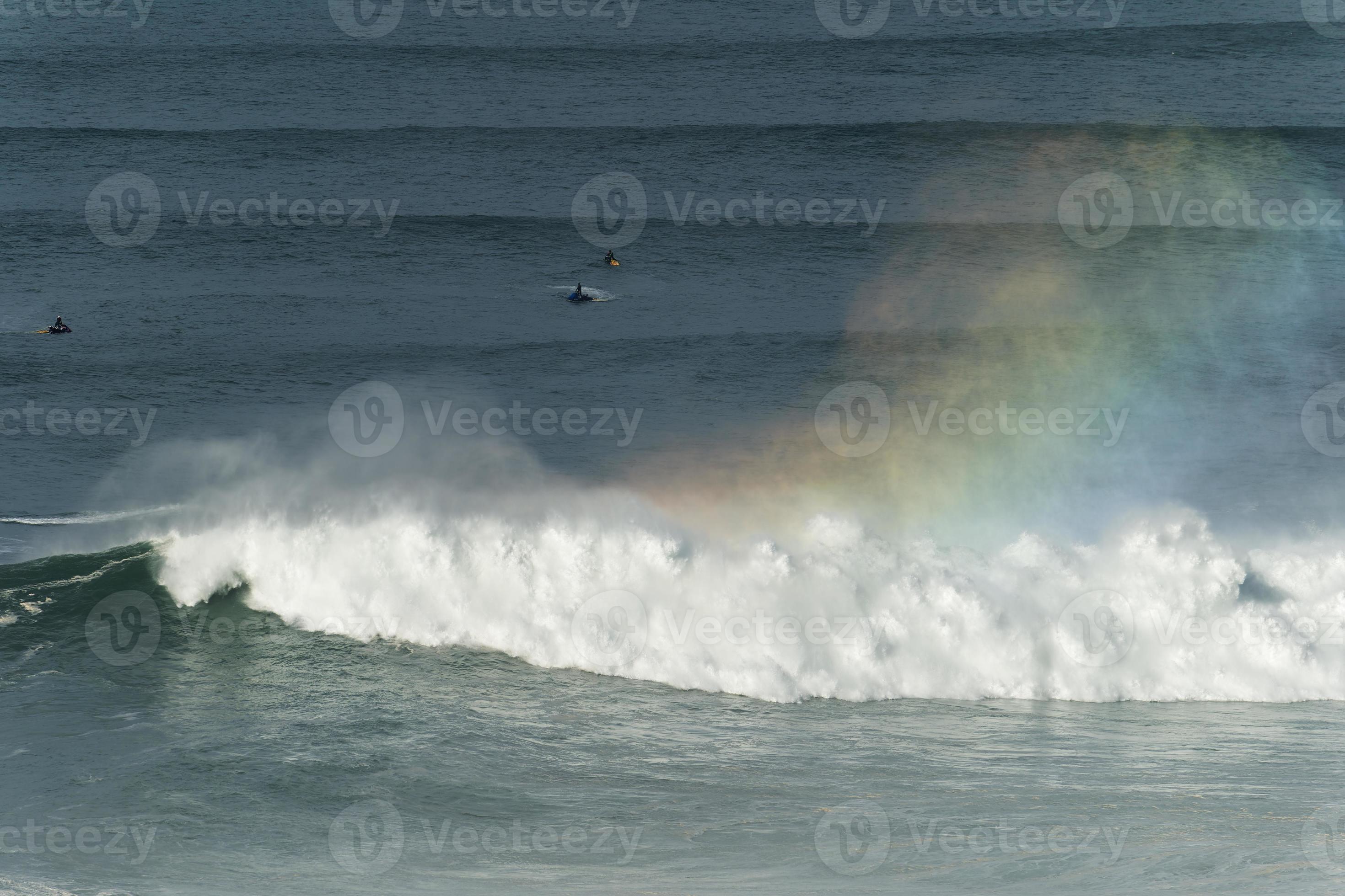 Big giant waves crashing in Nazare, Portugal creating a rainbow in the ...