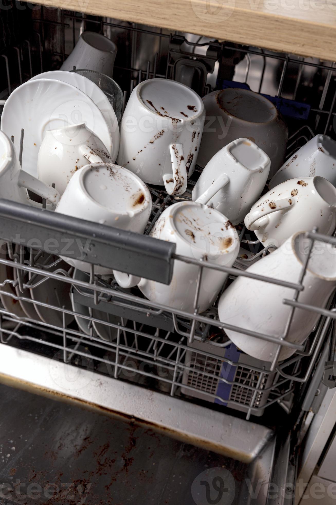 Unwashed, dirty dishes in dishwasher. Mess in the kitchen. Dirty ... Unwashed, dirty dishes in dishwasher. Mess in the kitchen. Dirty ...