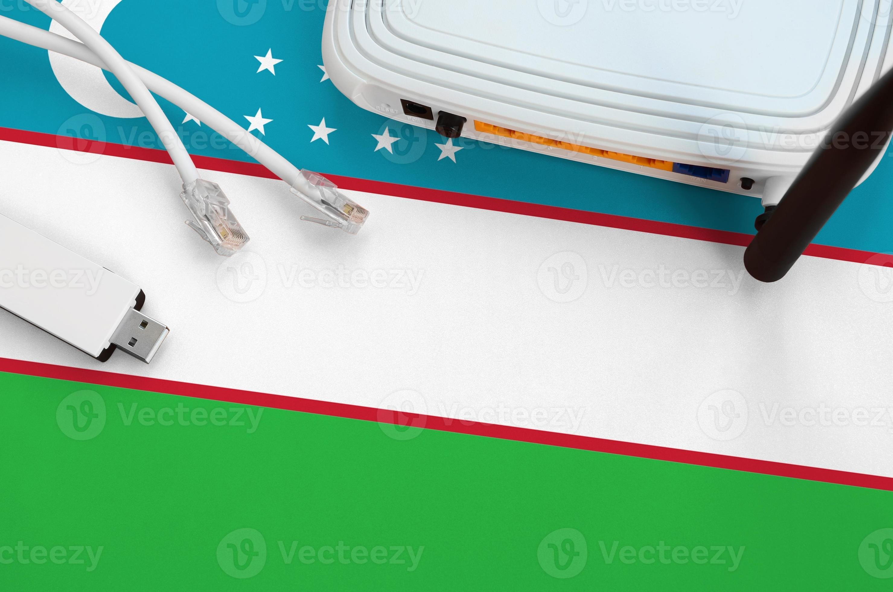 Uzbekistan flag depicted on table with internet rj45 cable, wireless usb wifi adapter and router ...