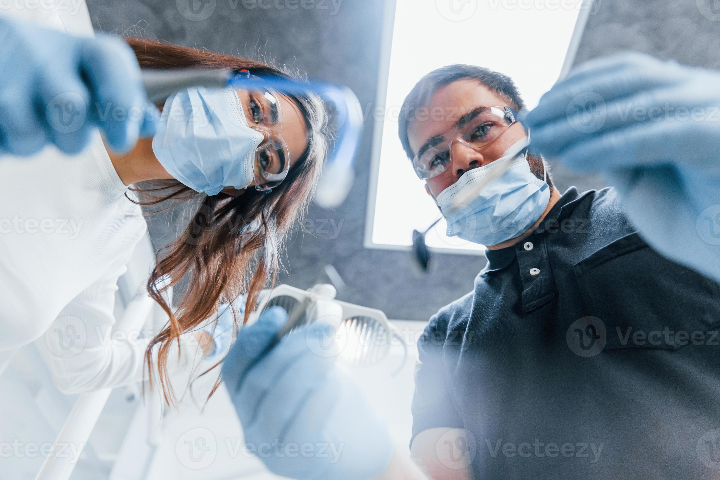 Male and female dentists working in the office together. First person view 15250515 Stock Photo ...