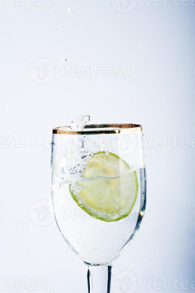 Lime splashing into glass of water 15252125 Stock Photo at Vecteezy