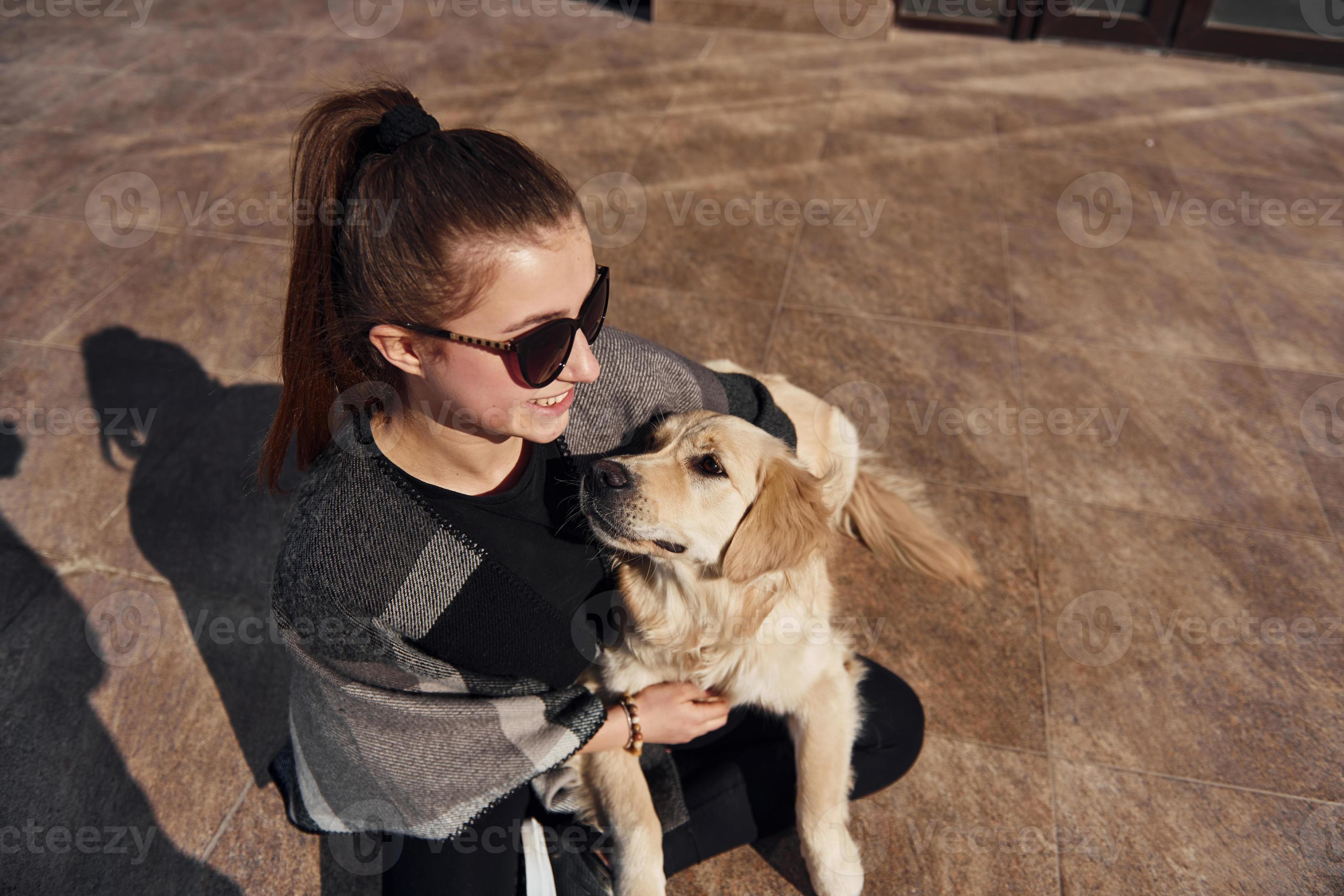 Young positive woman have fun with her dog when have a walk outdoors ... Young positive woman have fun with her dog when have a walk outdoors ...
