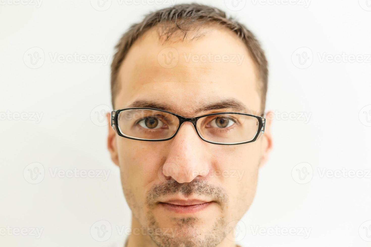 Young man puts his glasses on 15275208 Stock Photo at Vecteezy