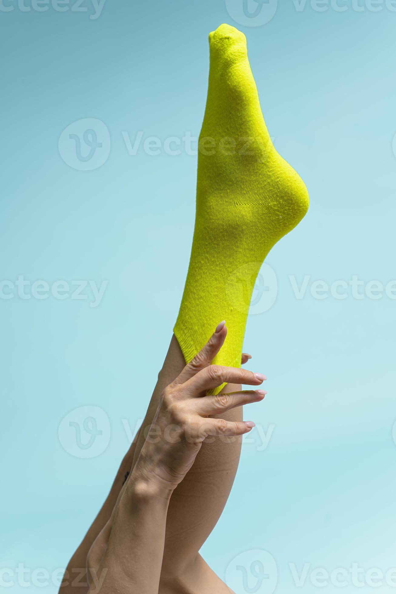 Woman With Beautiful Legs Wears Green Socks On Her Feet Isolated On Blue Background 15275992