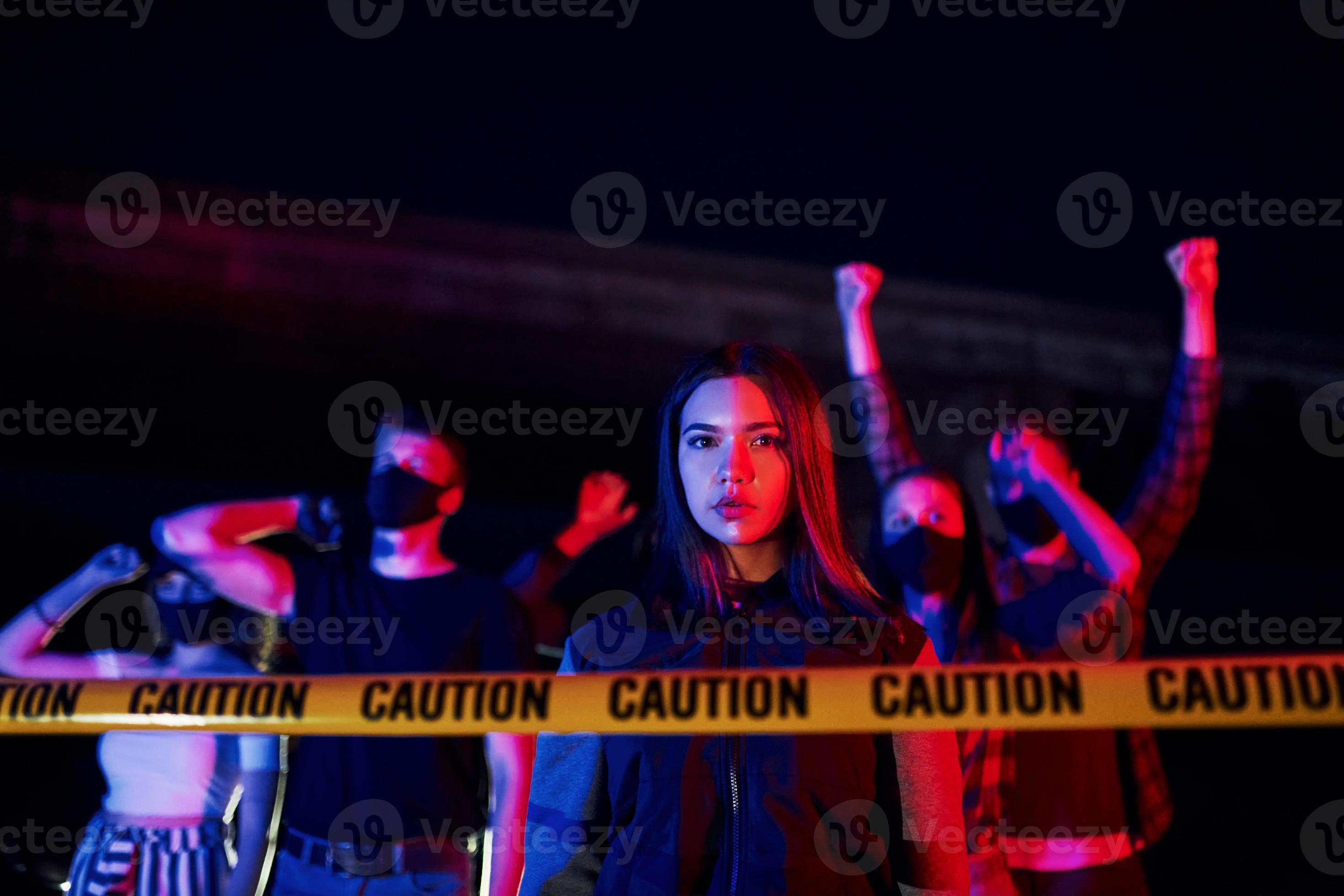 Beautiful woman near police border line. Group of protesting young ... Beautiful woman near police border line. Group of protesting young ...
