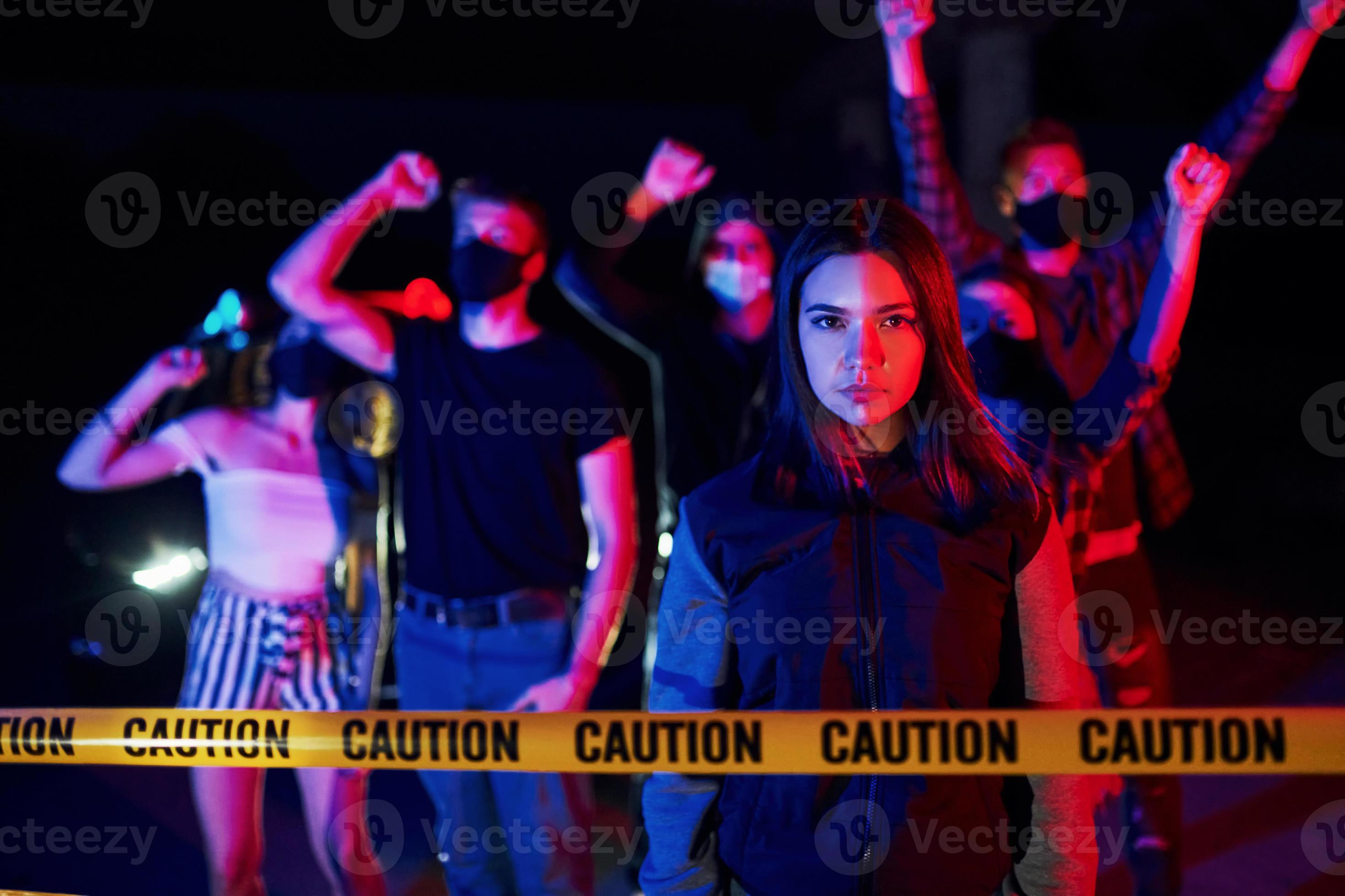 Beautiful woman near police border line. Group of protesting young ... Beautiful woman near police border line. Group of protesting young ...