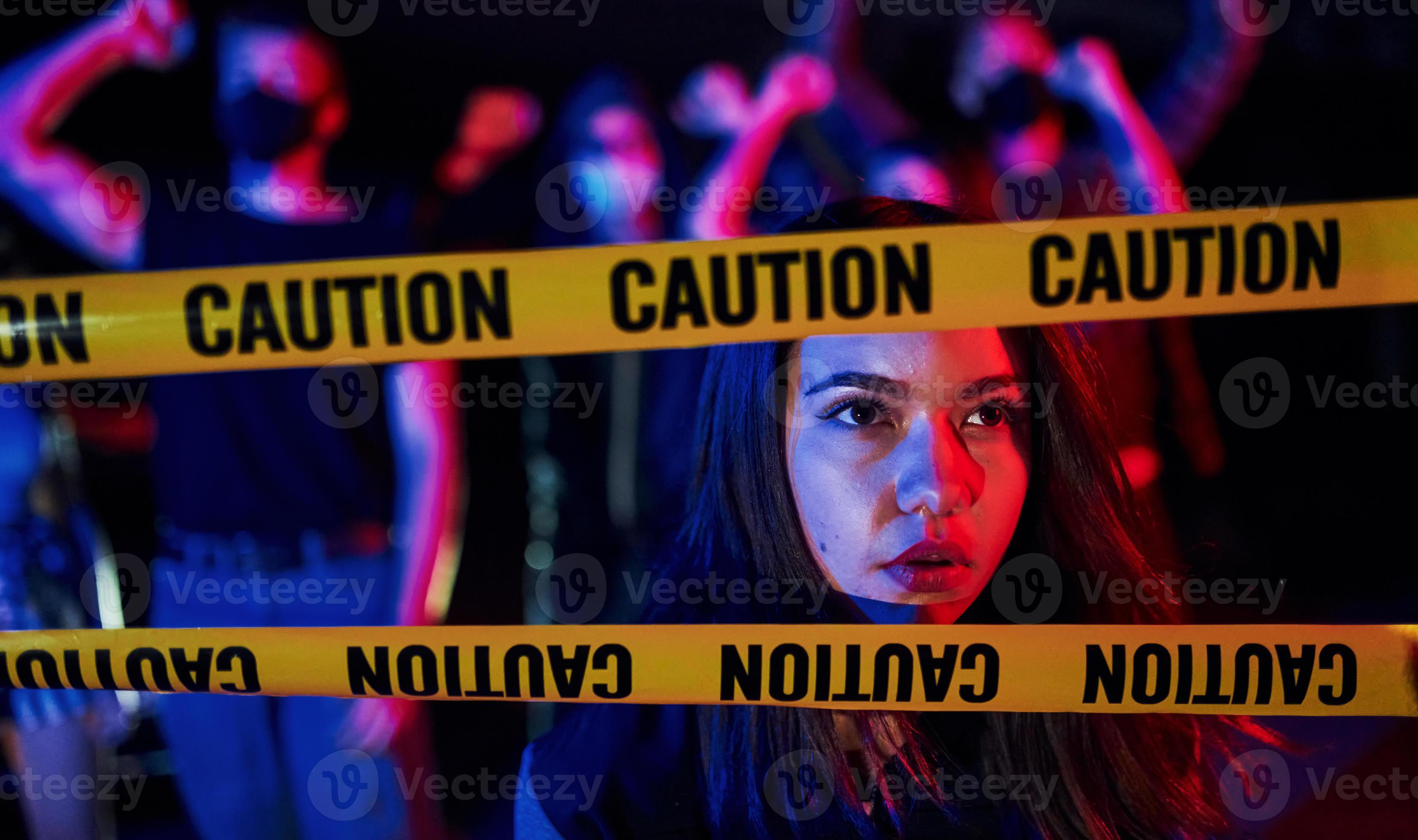 Beautiful woman near police border line. Group of protesting young ... Beautiful woman near police border line. Group of protesting young ...