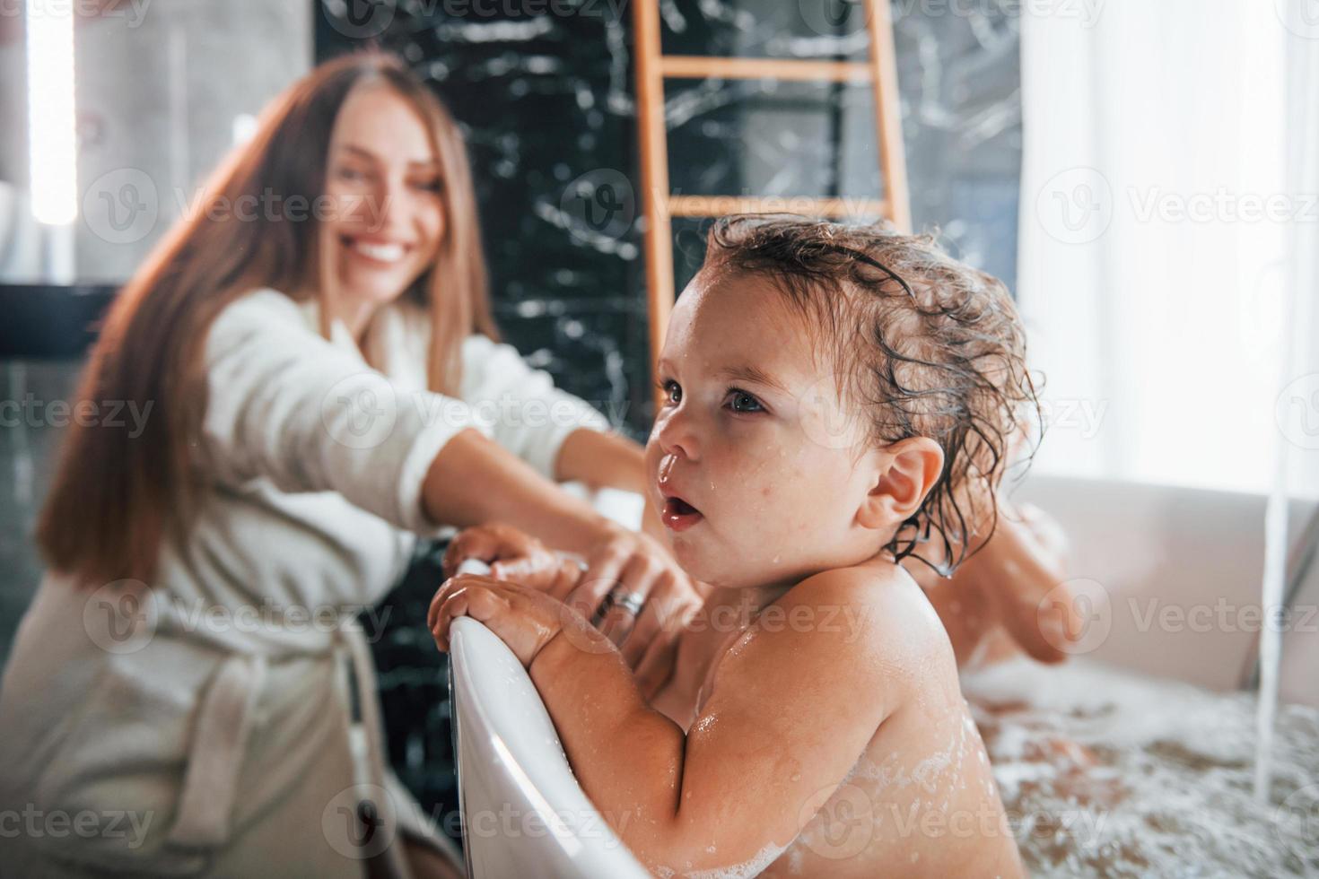 Young mother helps her son and daughter. Two kids washing in the bath 15362659 Stock Photo at ...