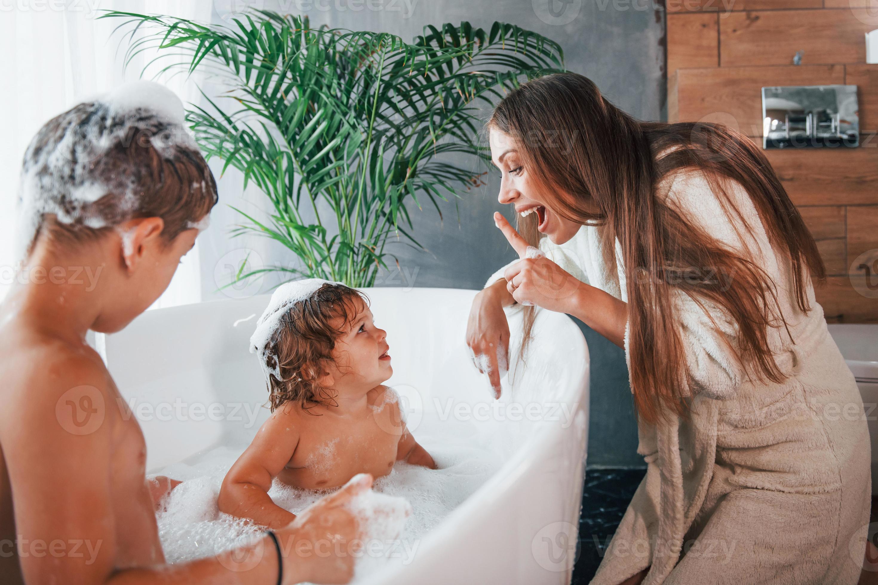 Having fun. Young mother helps her son and daughter. Two kids washing in the bath 15362931 Stock ...