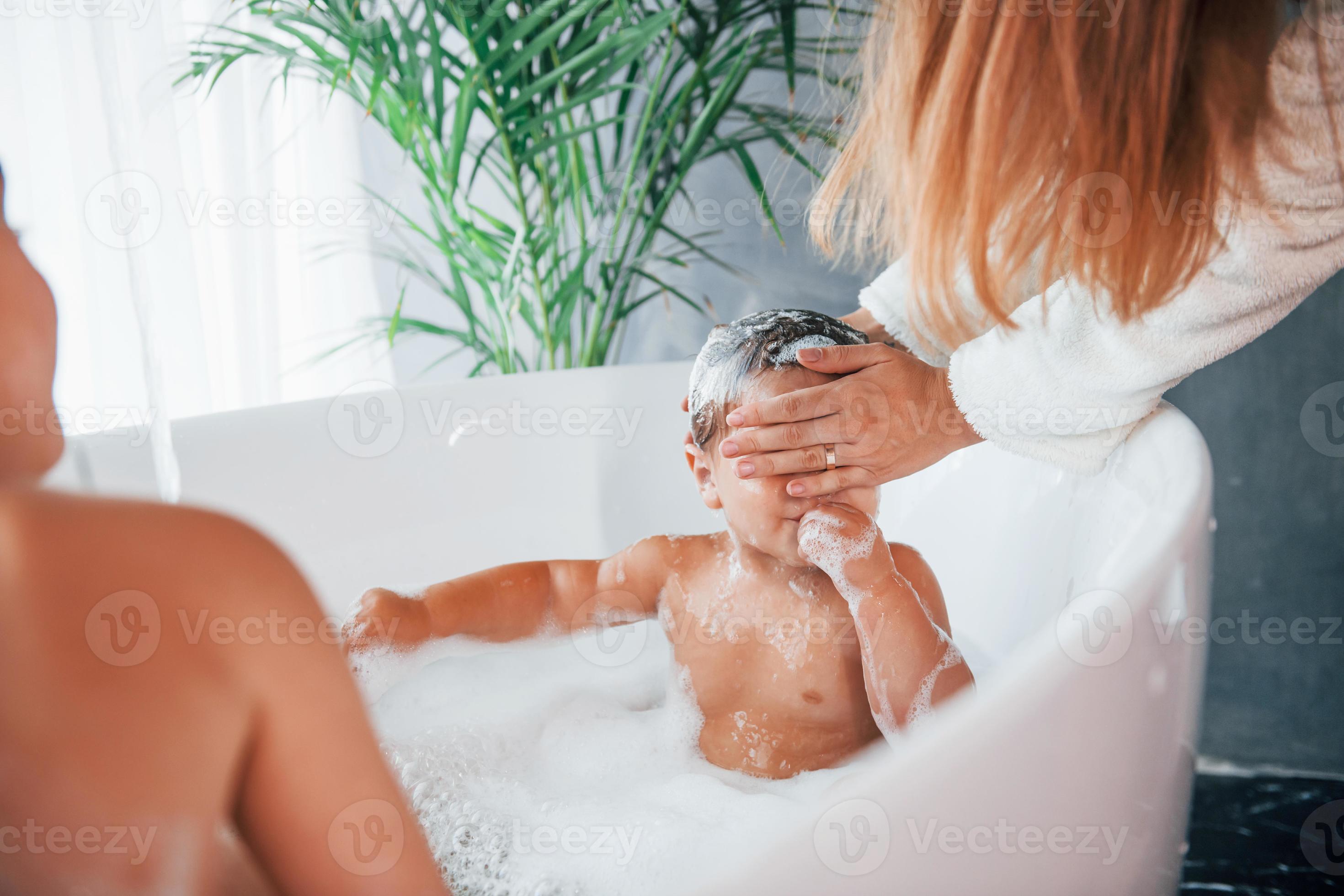 Having fun. Young mother helps her son and daughter. Two kids washing in the bath 15362939 Stock ...