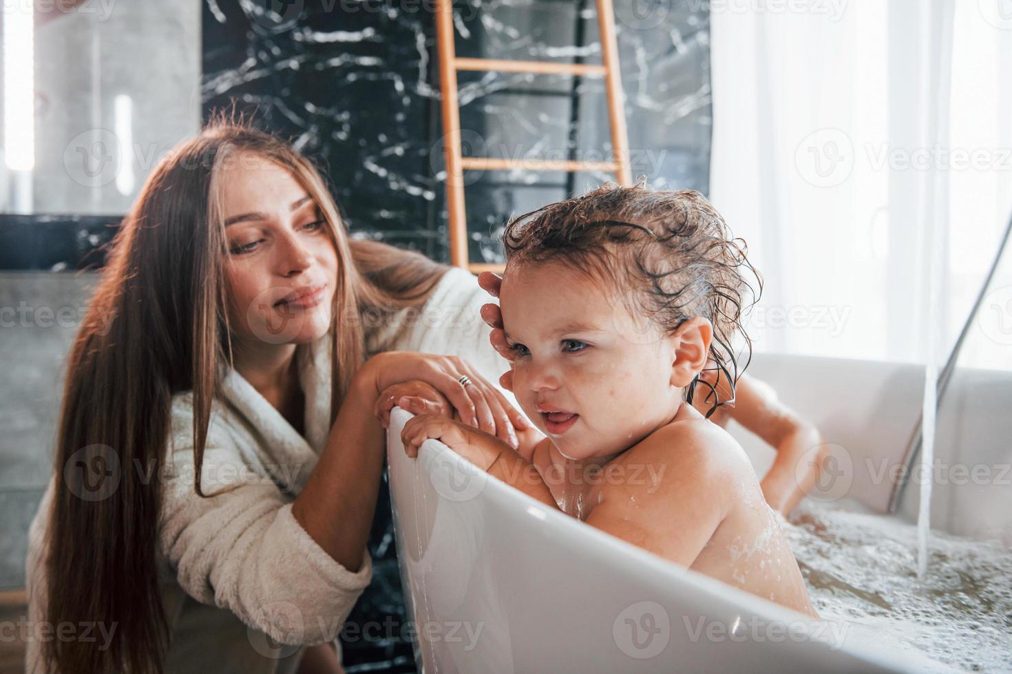 Young mother helps her son and daughter. Two kids washing in the bath 15362983 Stock Photo at ...