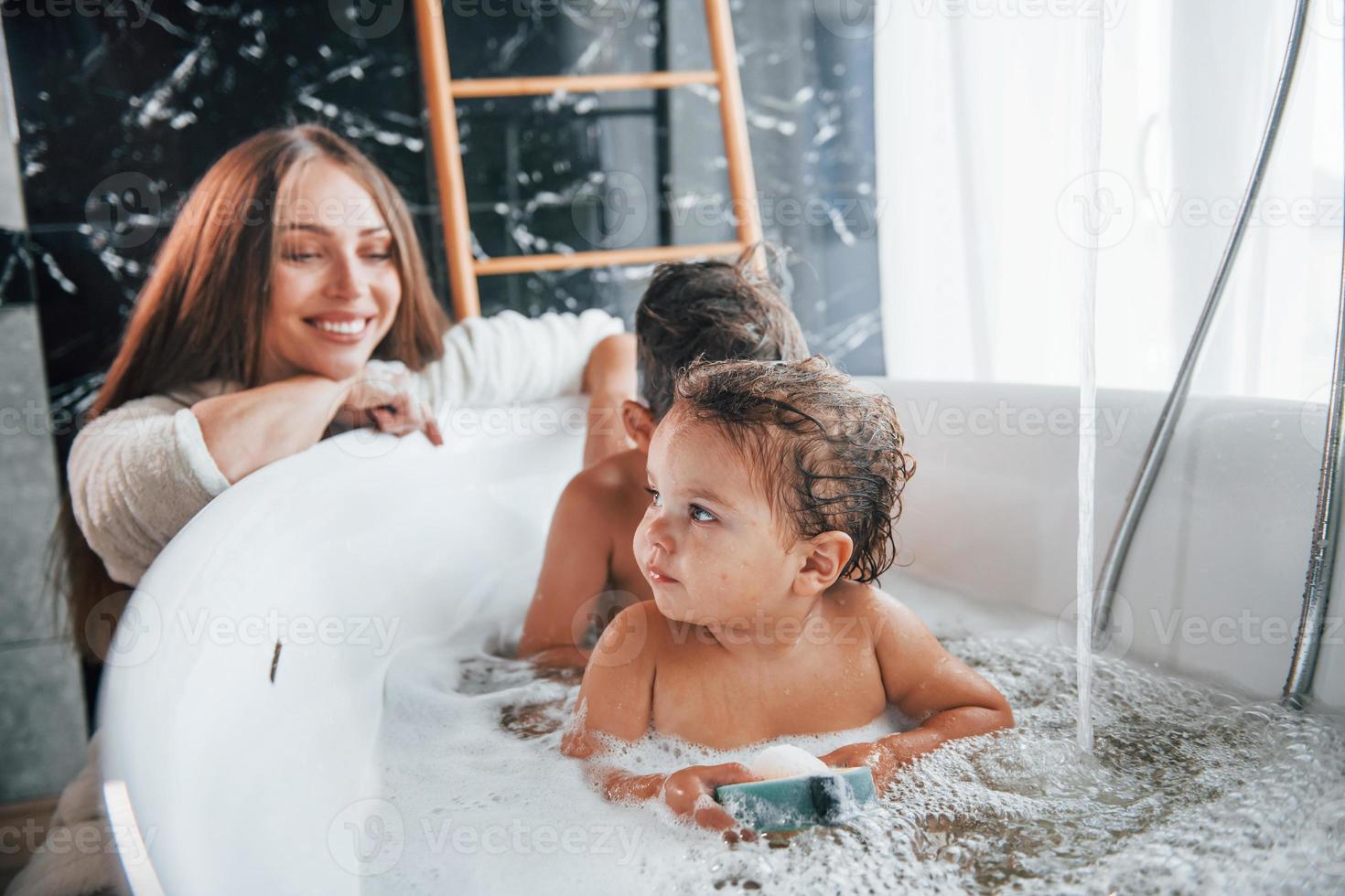Young mother helps her son and daughter. Two kids washing in the bath 15362987 Stock Photo at ...