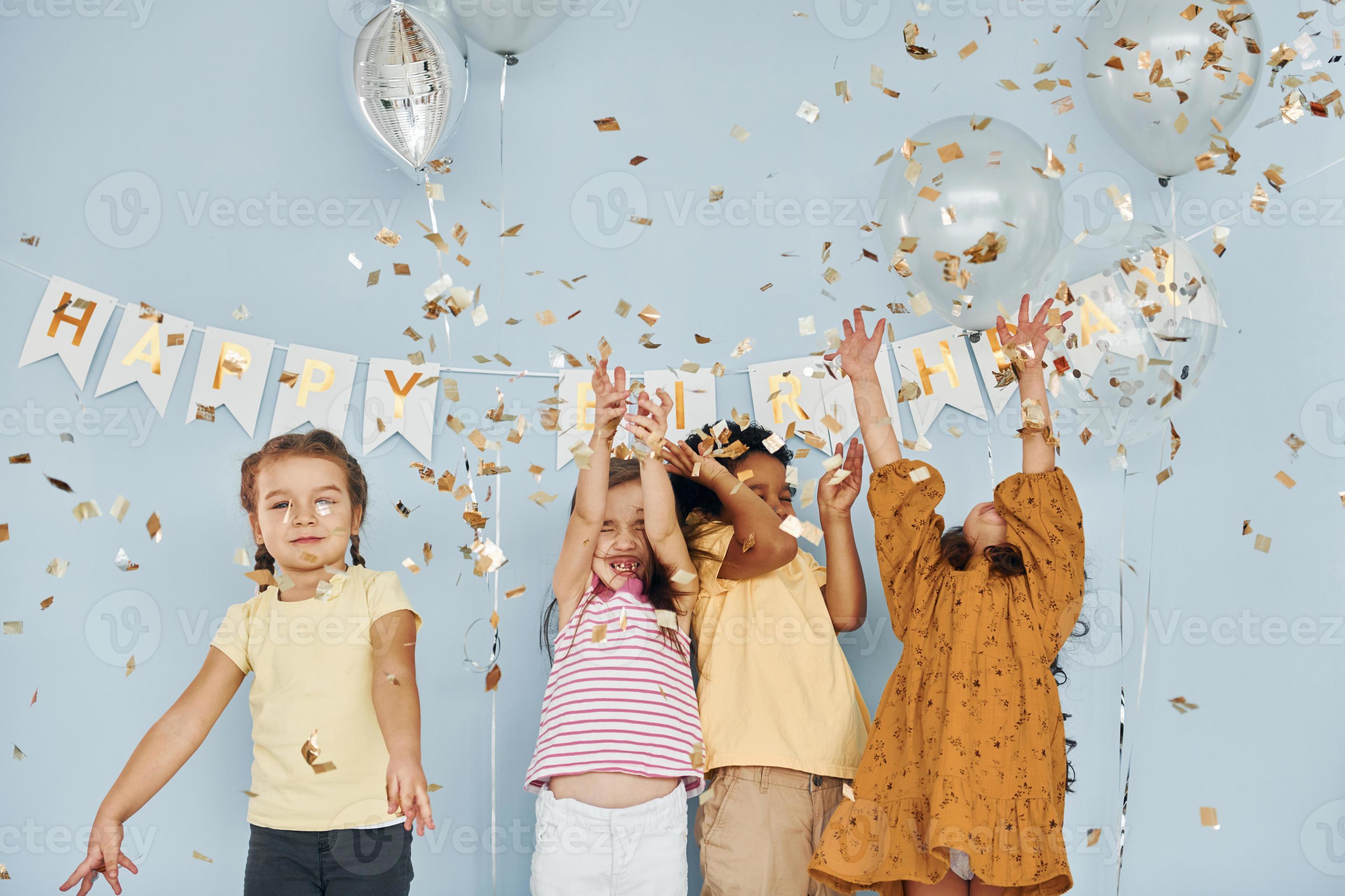 Balloons and confetti. Children on celebrating birthday party indoors have fun together 15364625 ...