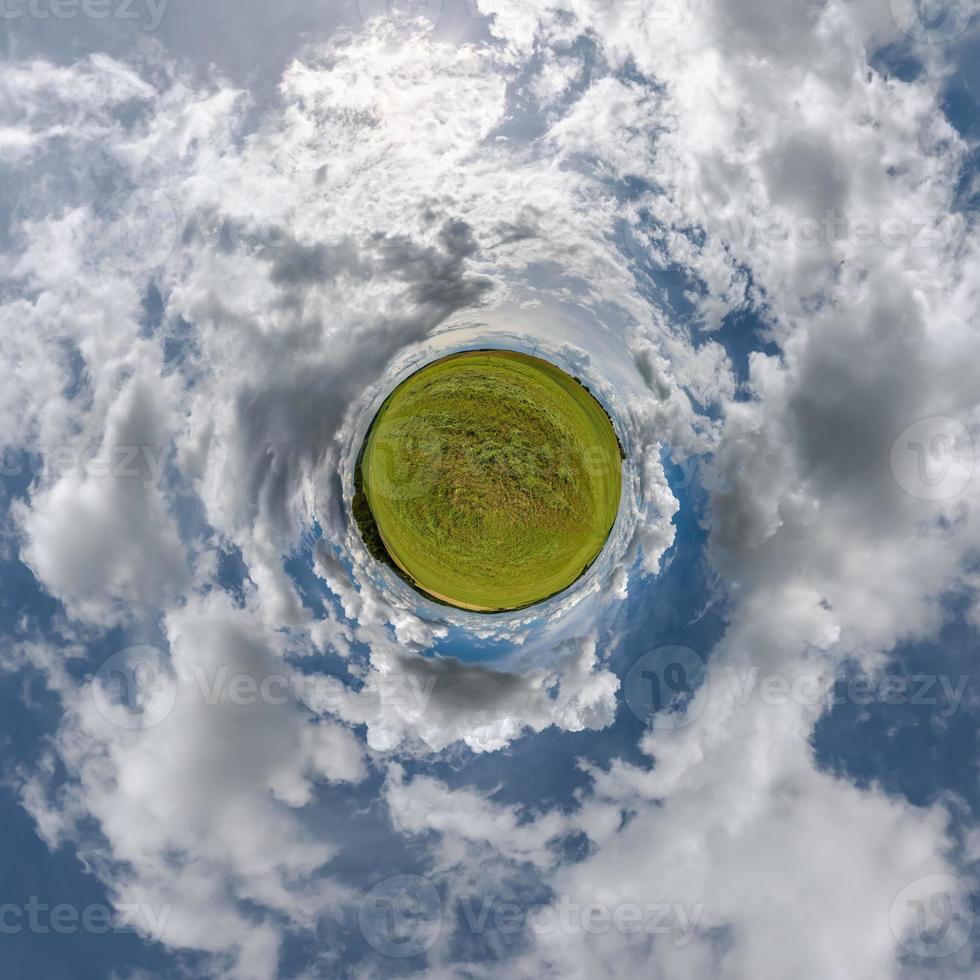 green tiny planet in blue sky with beautiful clouds with transformation ...