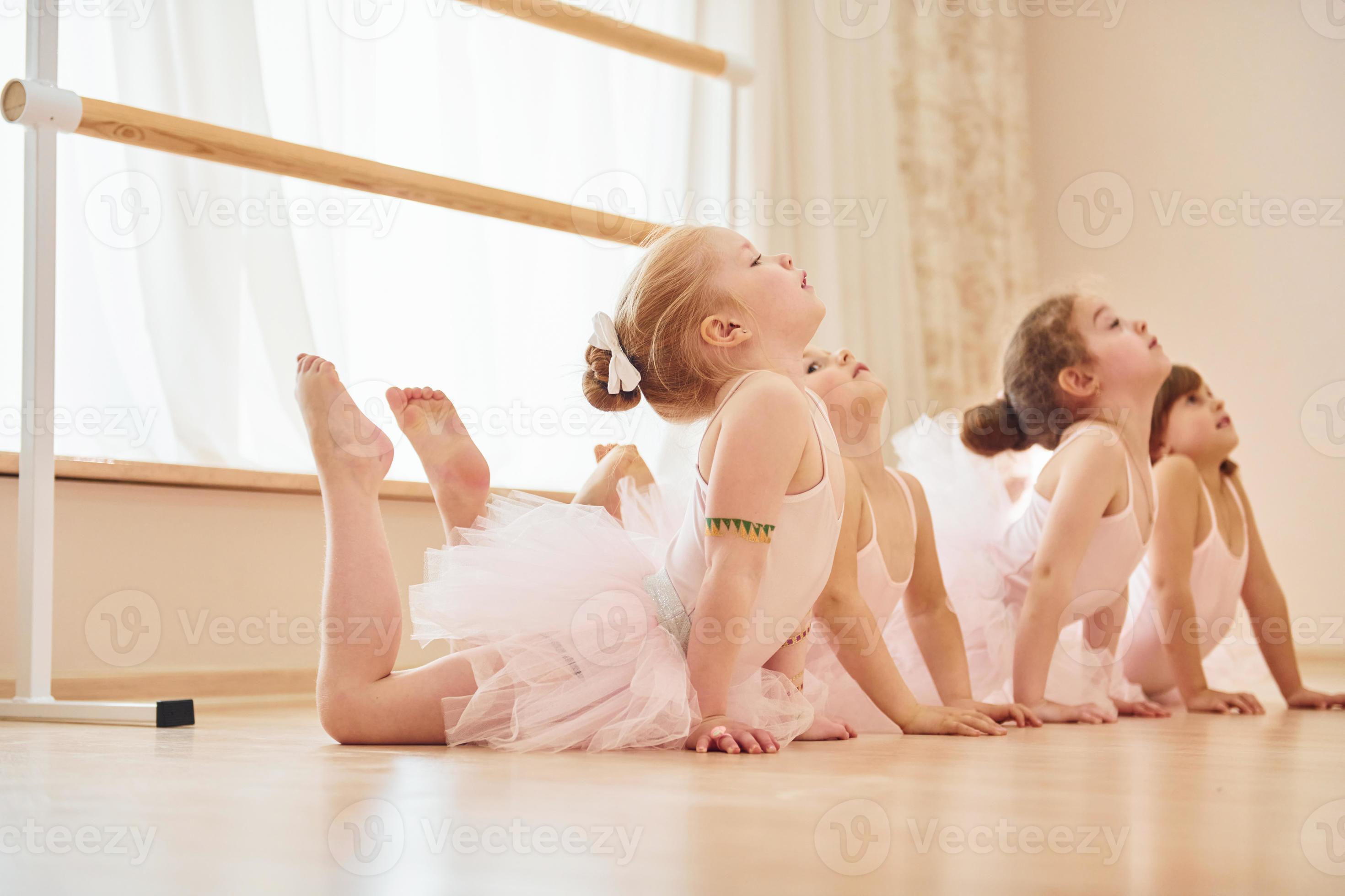 Stretching exercises. Little ballerinas preparing for performance 15419346 Stock Photo at Vecteezy