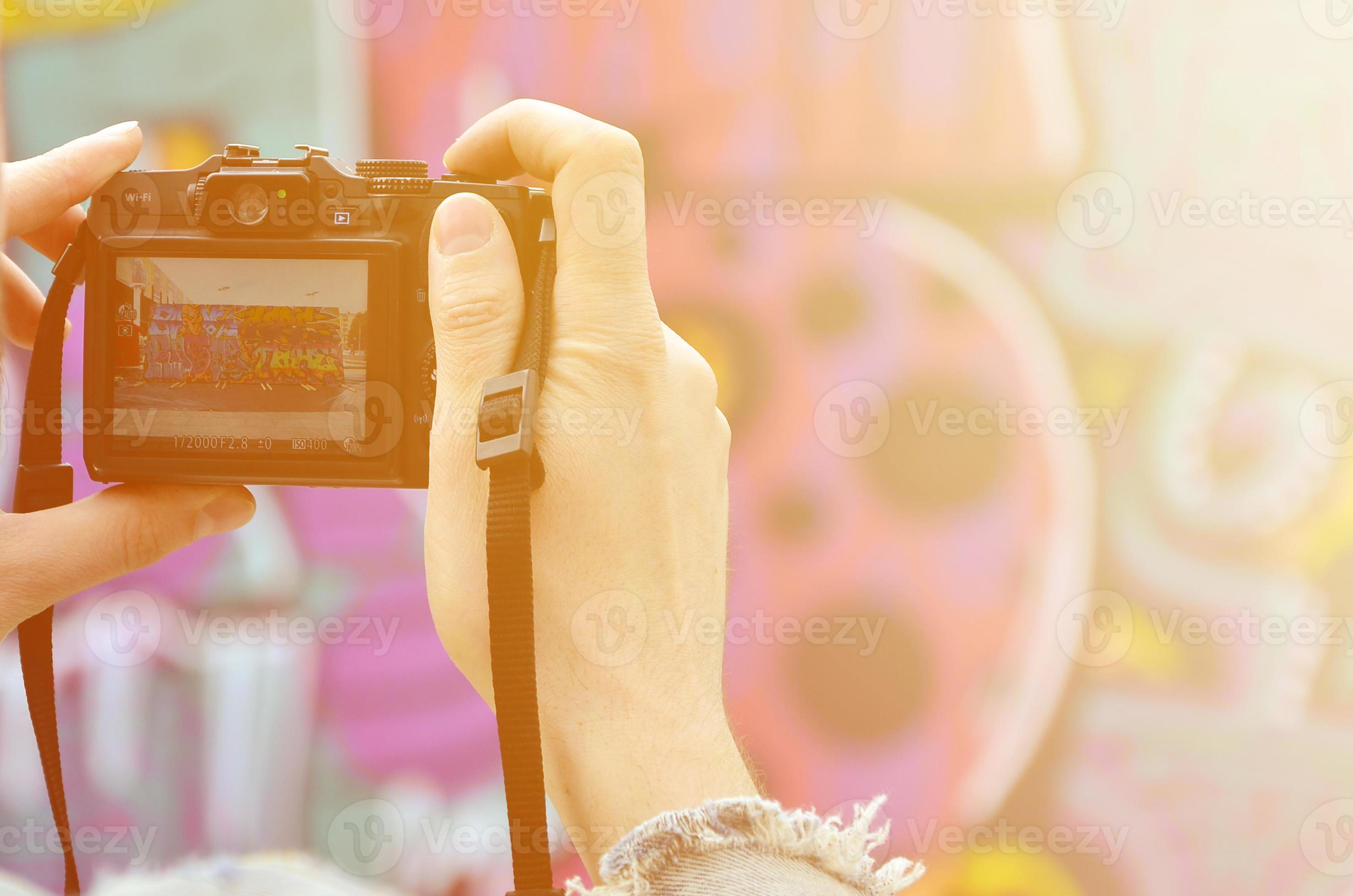 A young graffiti artist photographs his completed picture on the wall ... A young graffiti artist photographs his completed picture on the wall ...