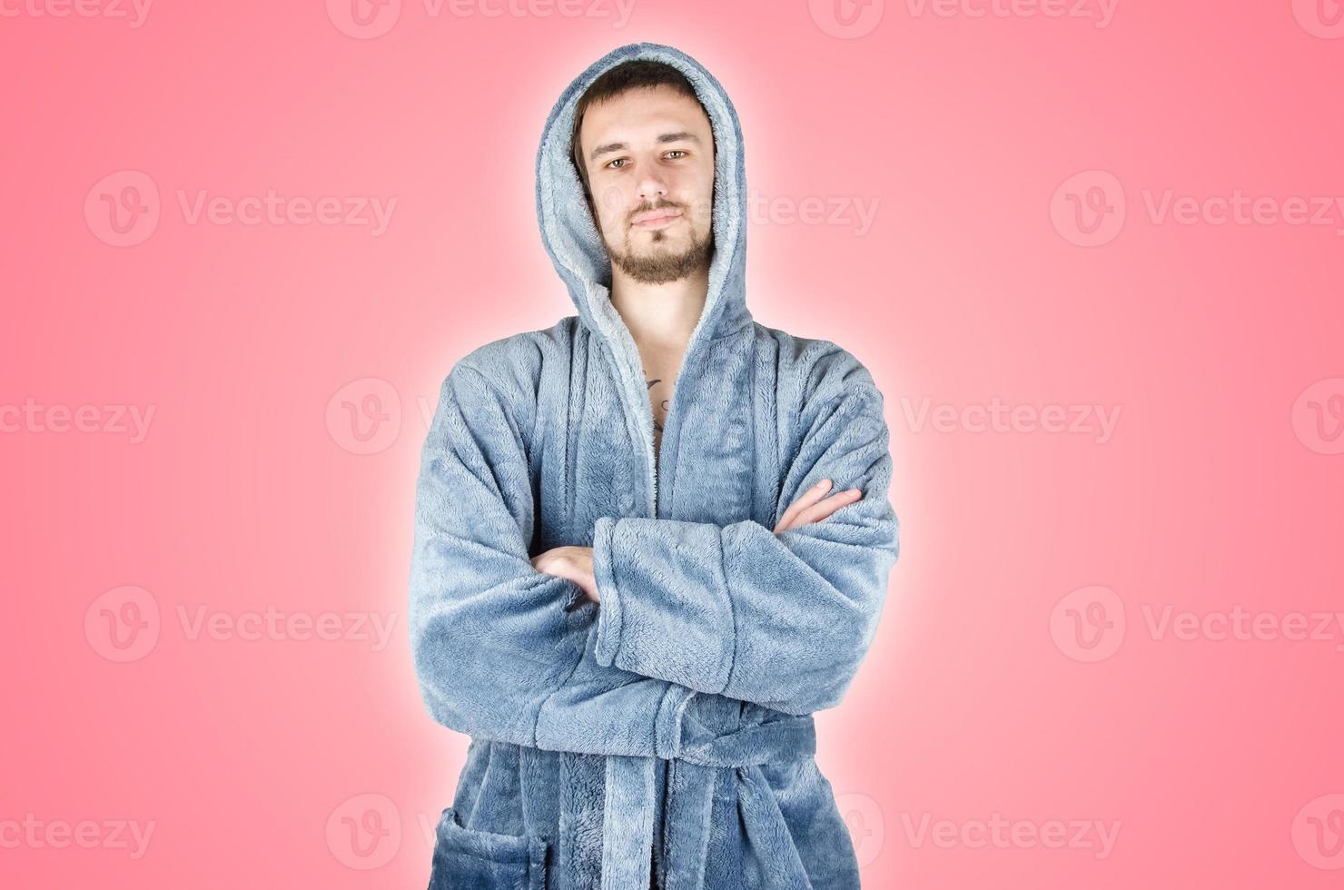 Portrait Of Young Caucasian Bearded Man In Blue Bathrobe With Crossed