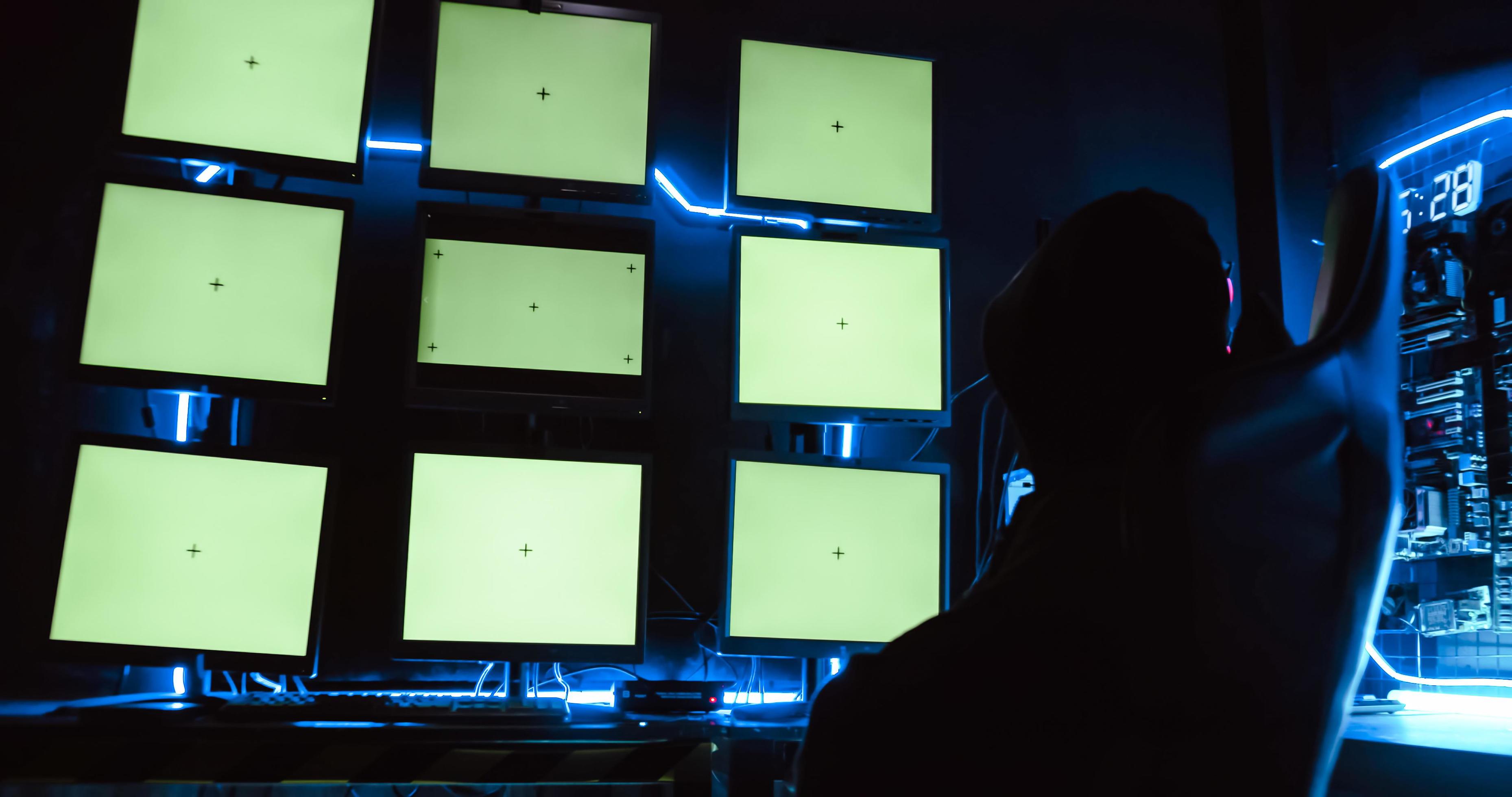 A male hacker is using a computer to hack data to demand ransom from ...