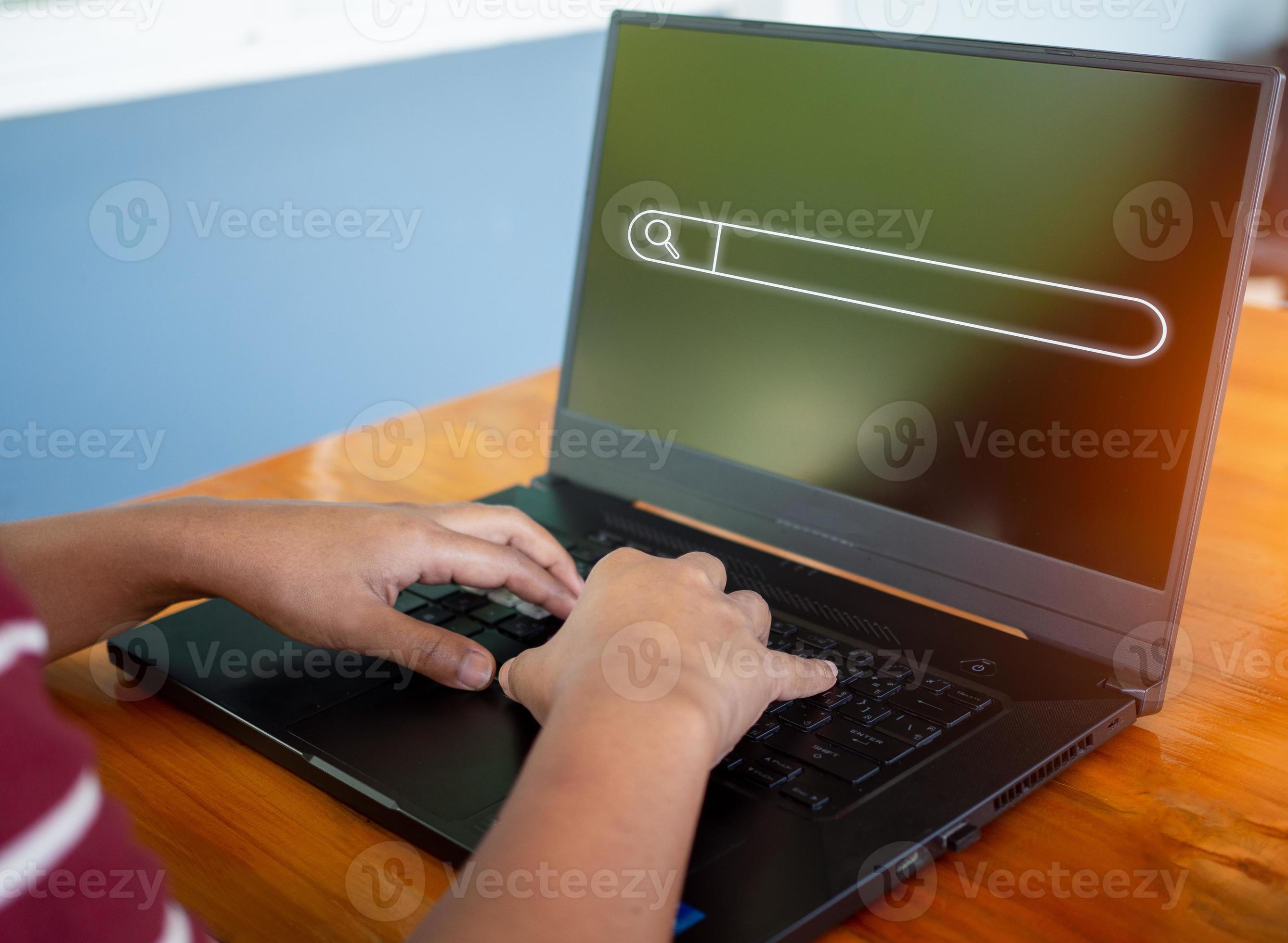 Human hand working on computer and search icon. The concept of ...