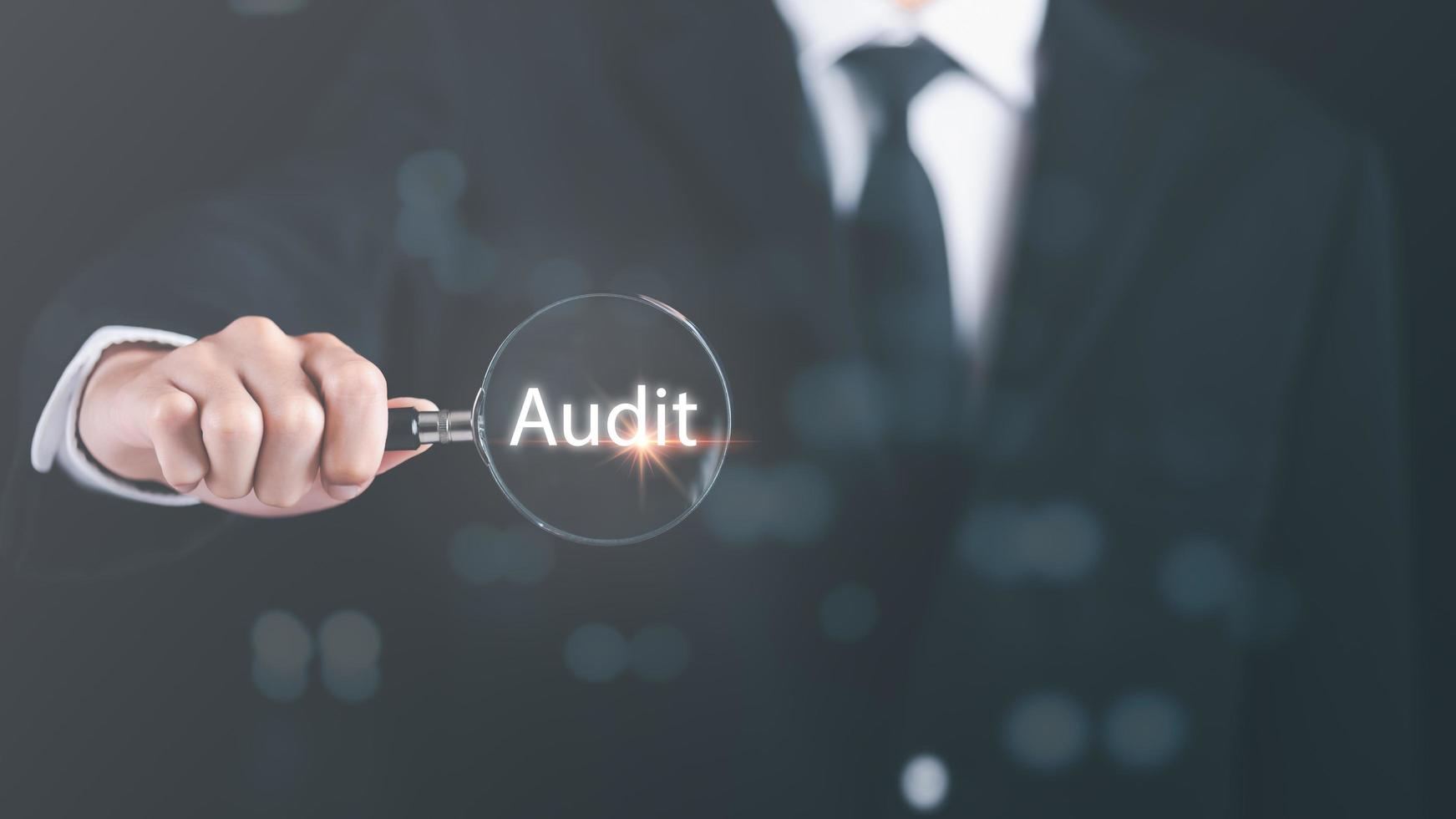 Businessman holding a magnifying glass,Audit Document Concepts, quality ... Businessman holding a magnifying glass,Audit Document Concepts, quality ...