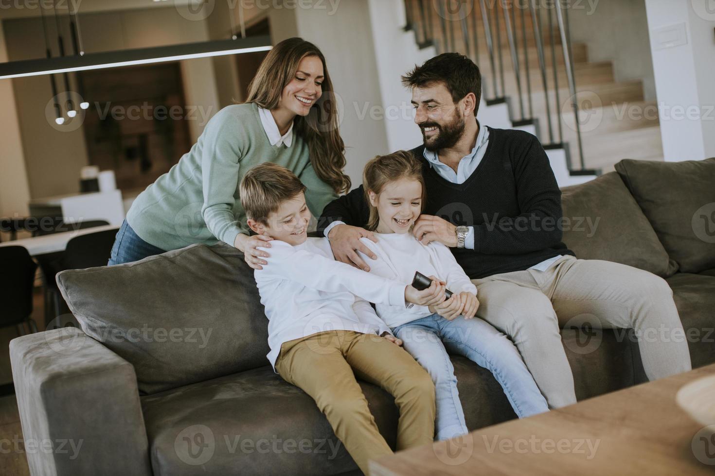 Siblings fighting over TV remote control at home 15741797 Stock Photo ...