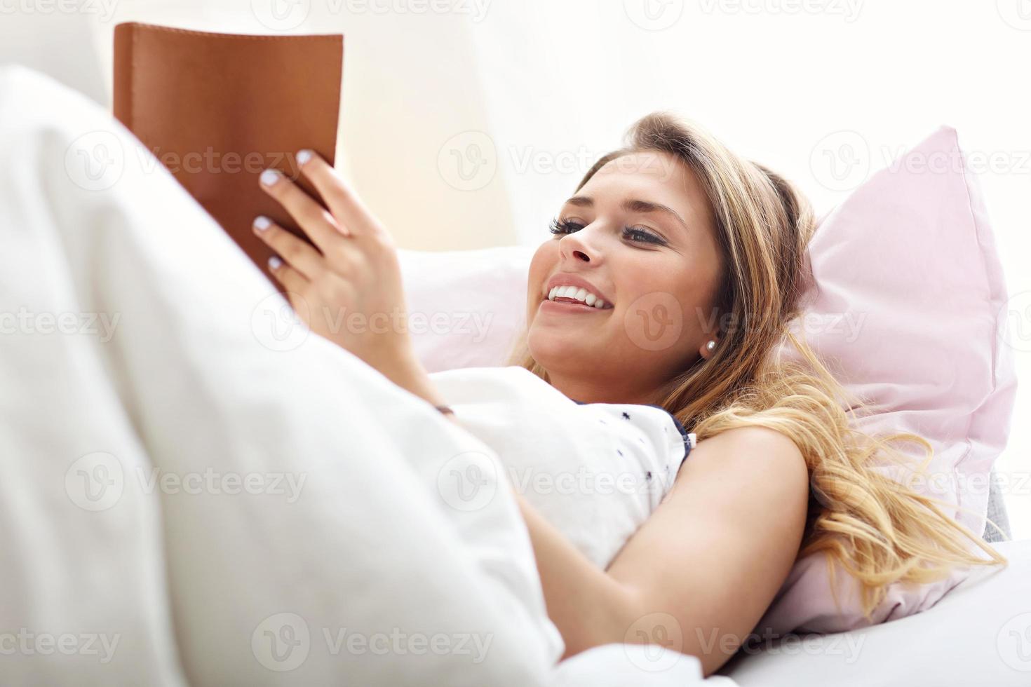 Happy Teen Girl Resting On Sofa At The Living Room While Reading Her