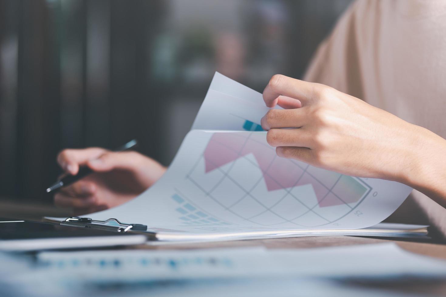 Business people read business statistics chart reports, to analyze and ... Business people read business statistics chart reports, to analyze and ...