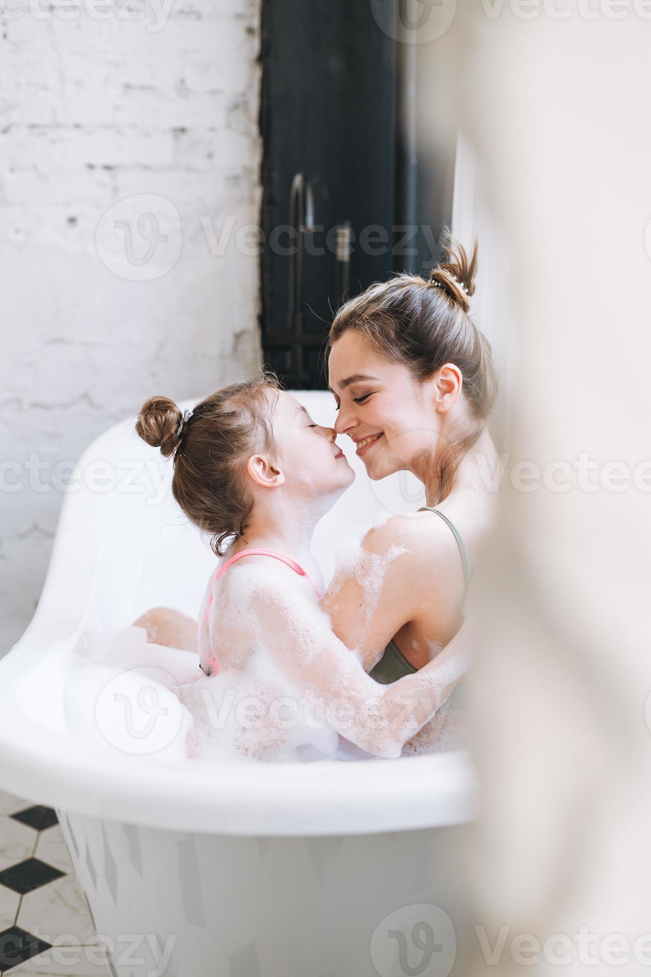 Young mother woman and little tween girl daughter having fun in bath ... Young mother woman and little tween girl daughter having fun in bath ...