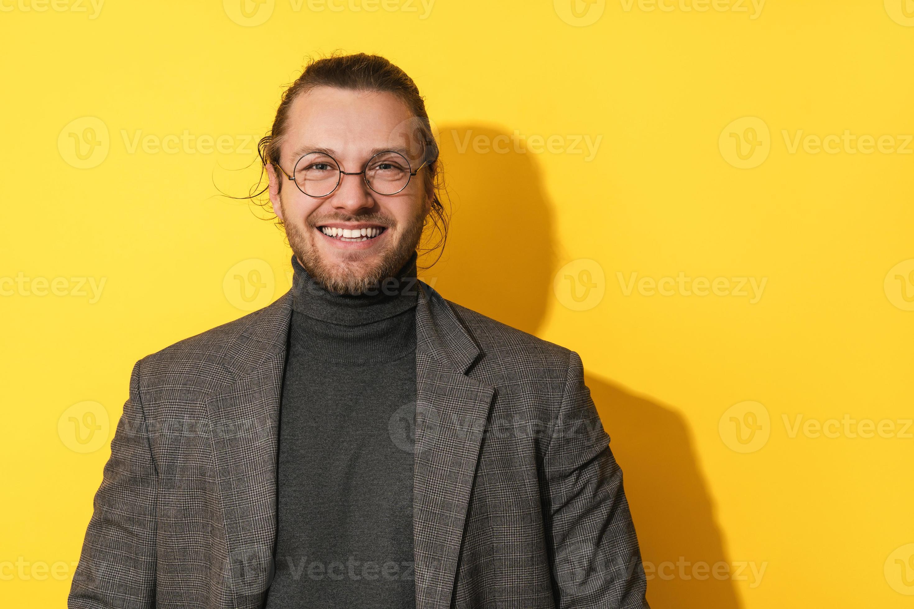 Handsome Bearded Man Wearing Glasses Smiling On Yellow Background