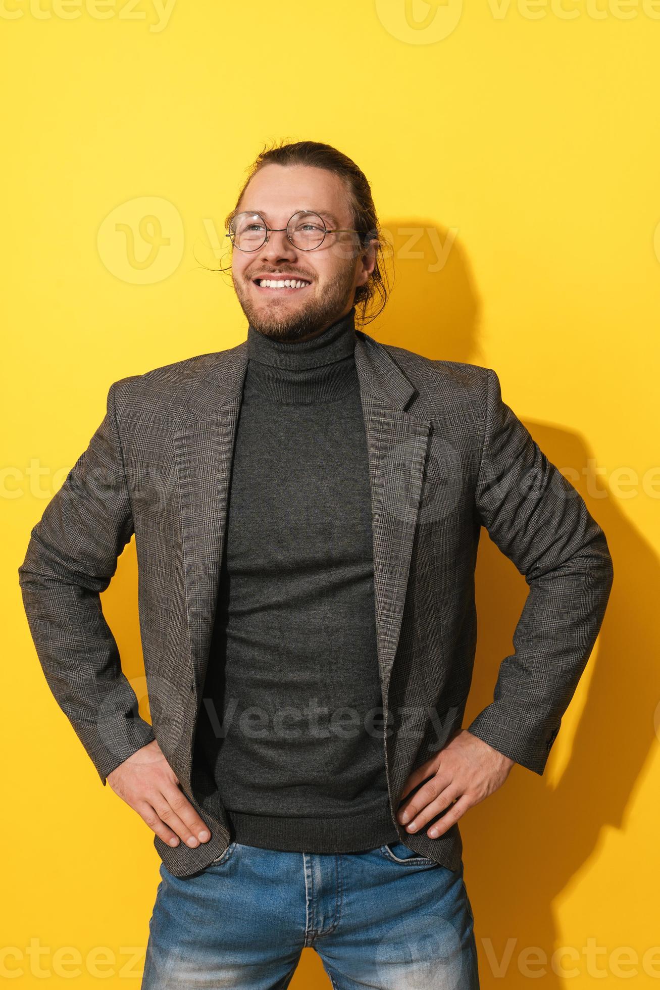 Handsome Bearded Man Wearing Glasses Smiling On Yellow Background
