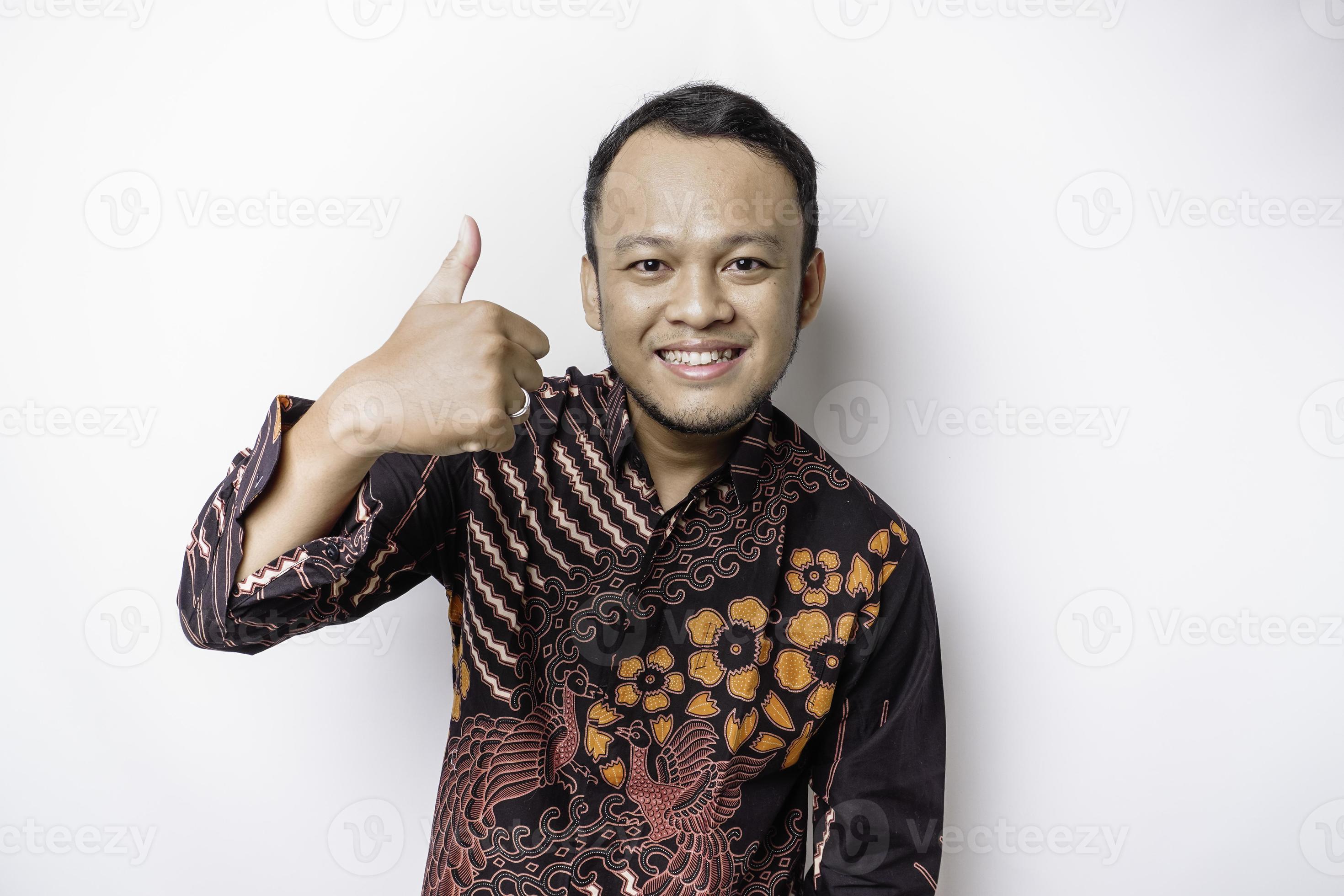 Excited Asian man wears batik shirt, gives thumbs up hand gesture of ...