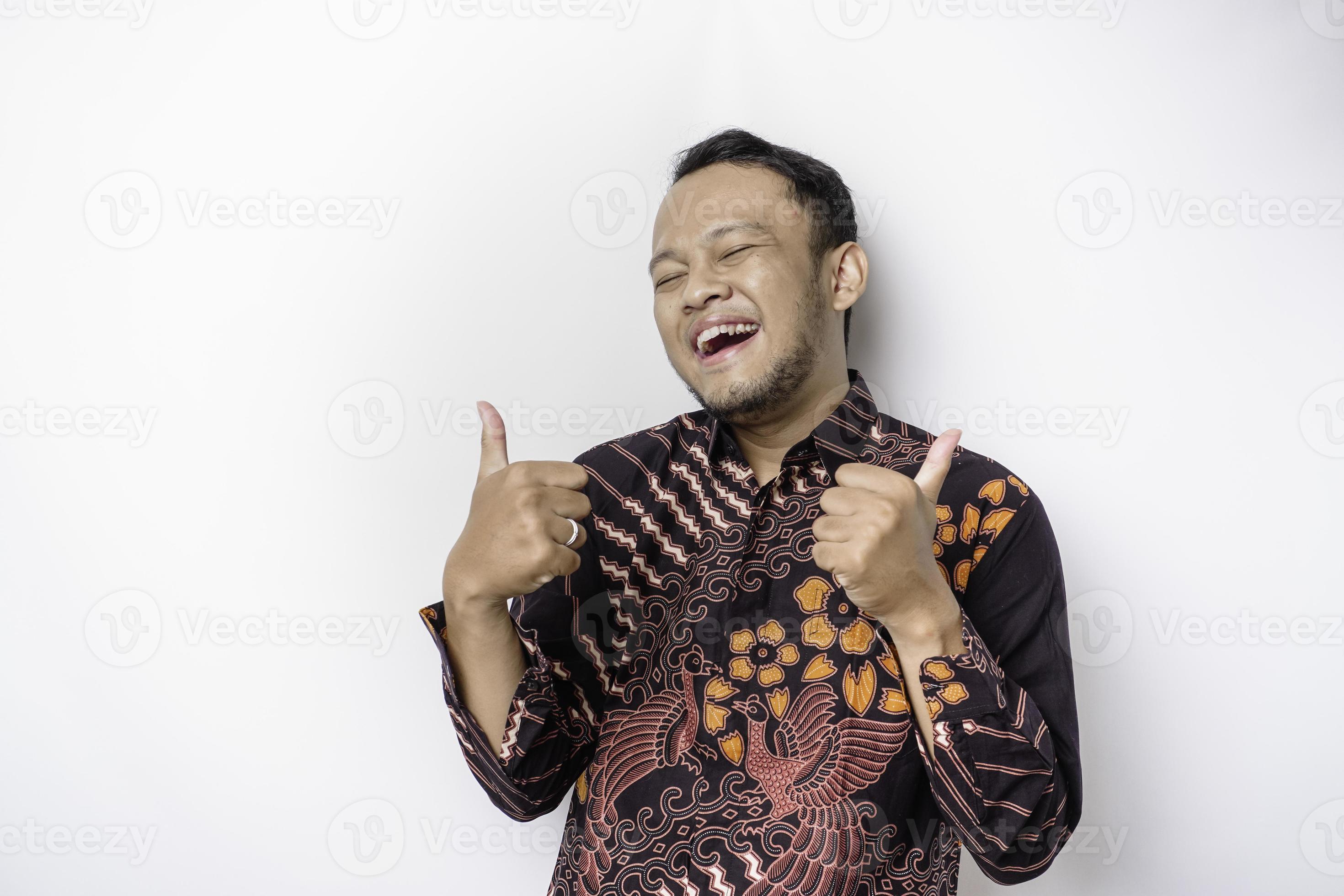 Excited Asian man wears batik shirt, gives thumbs up hand gesture of ...