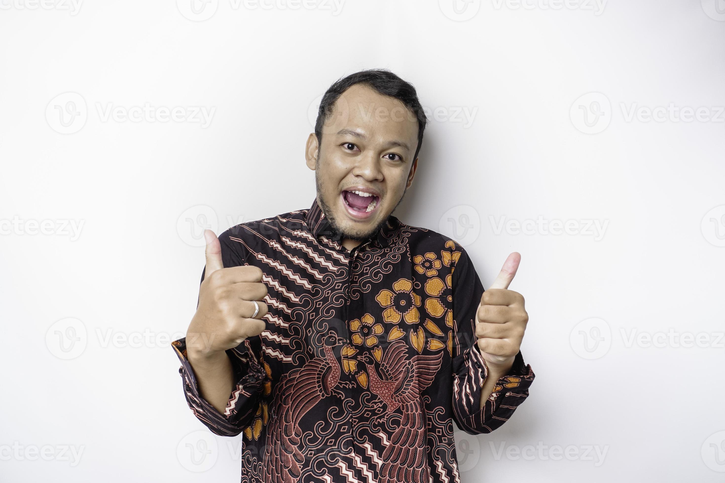 Excited Asian man wears batik shirt, gives thumbs up hand gesture of ...