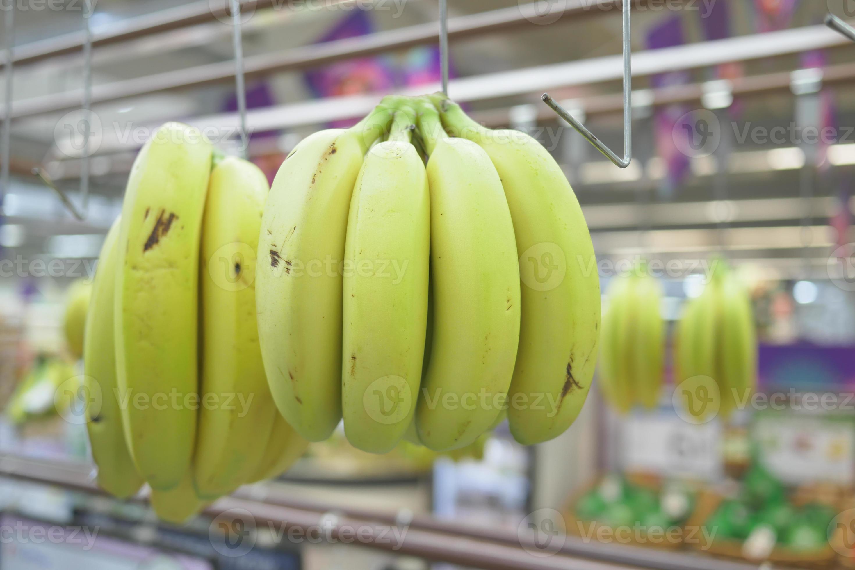 Close up of fresh banana hanging in a retail shop 16554895 Stock Photo at Vecteezy