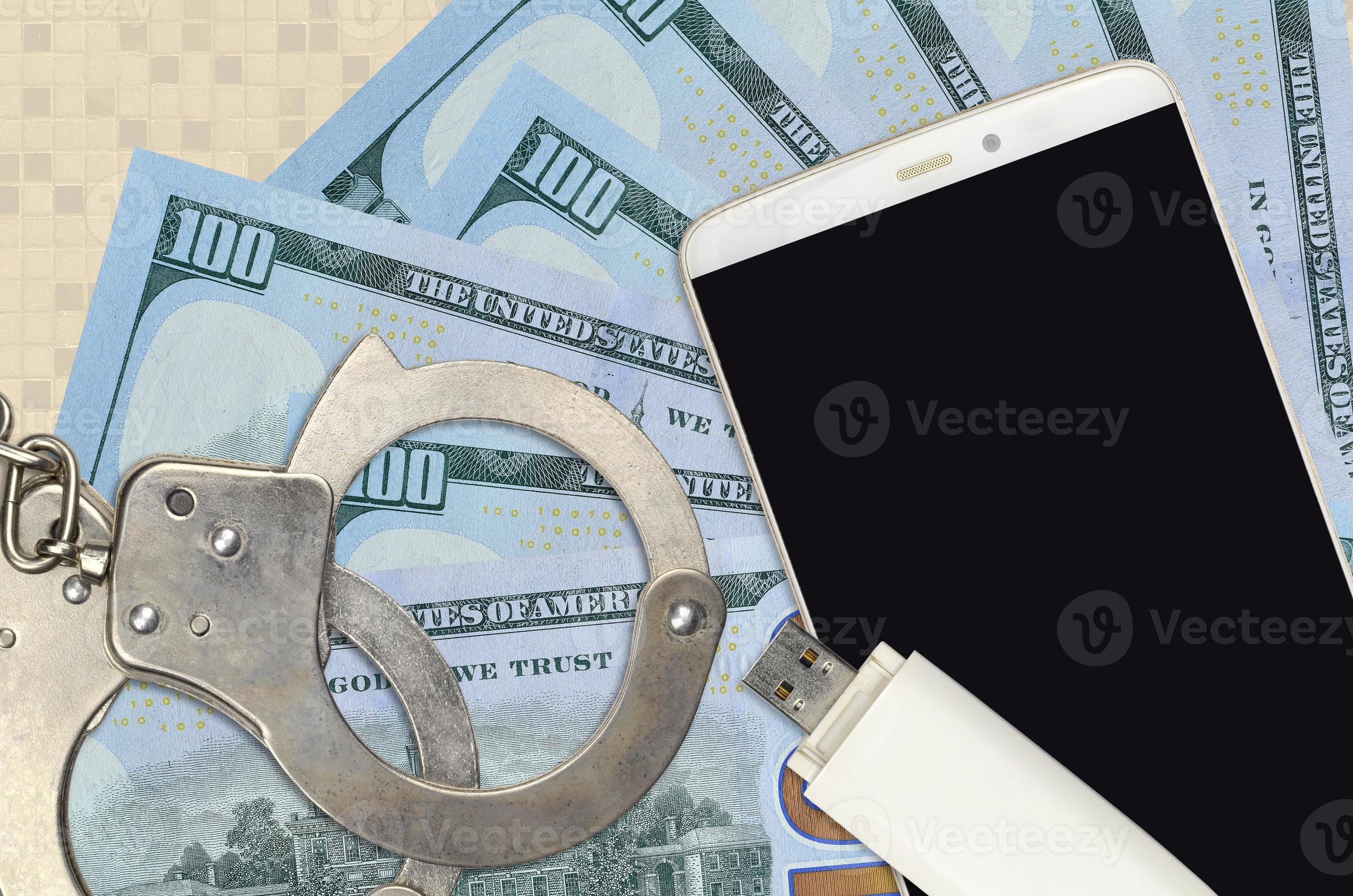 100 US dollars bills and smartphone with police handcuffs. Concept of ...