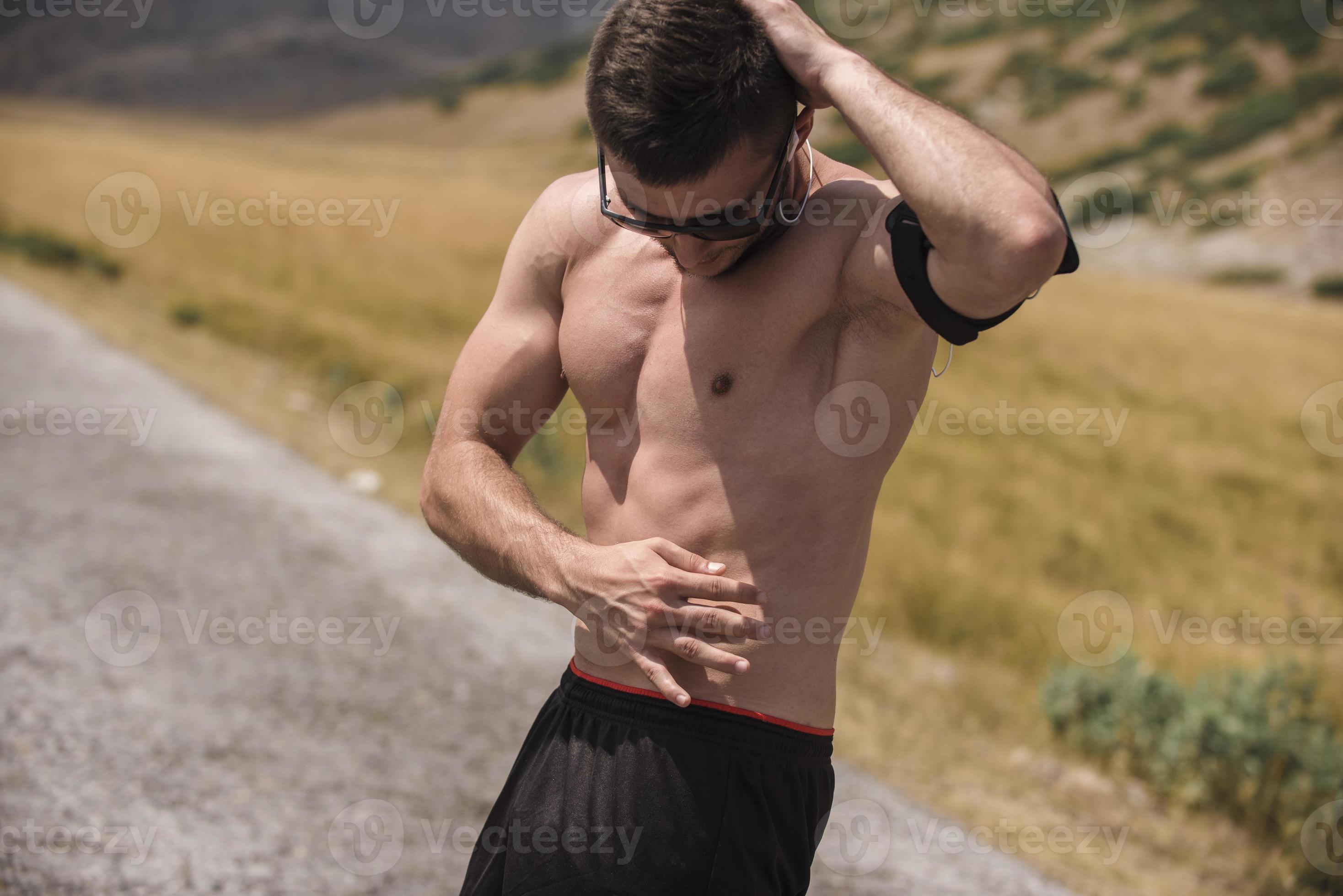 Athletic young man stretching after run in the nature. sport concept 16606343 Stock Photo at ...