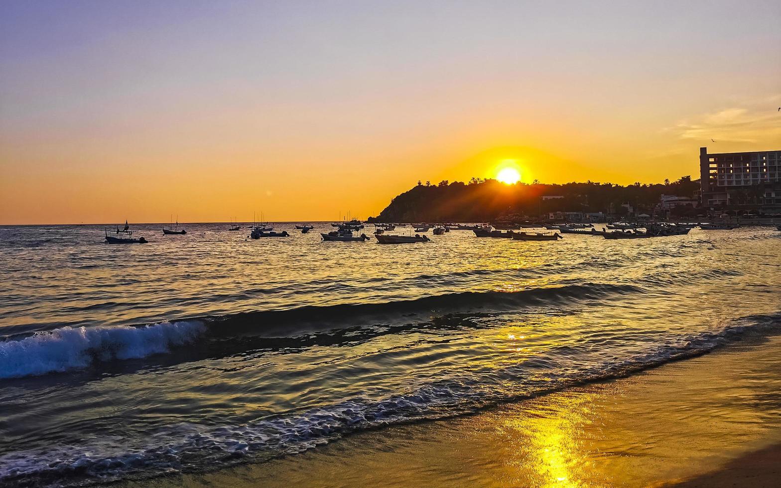Colorful golden sunset big wave and beach Puerto Escondido Mexico ...