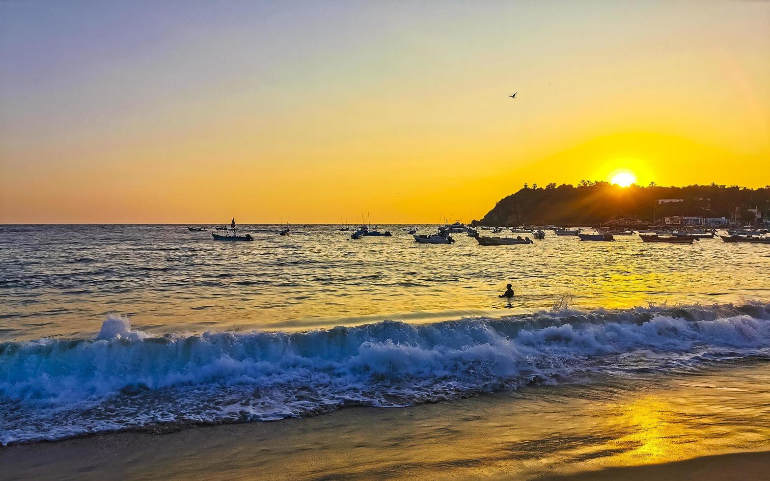 Colorful golden sunset big wave and beach Puerto Escondido Mexico ...