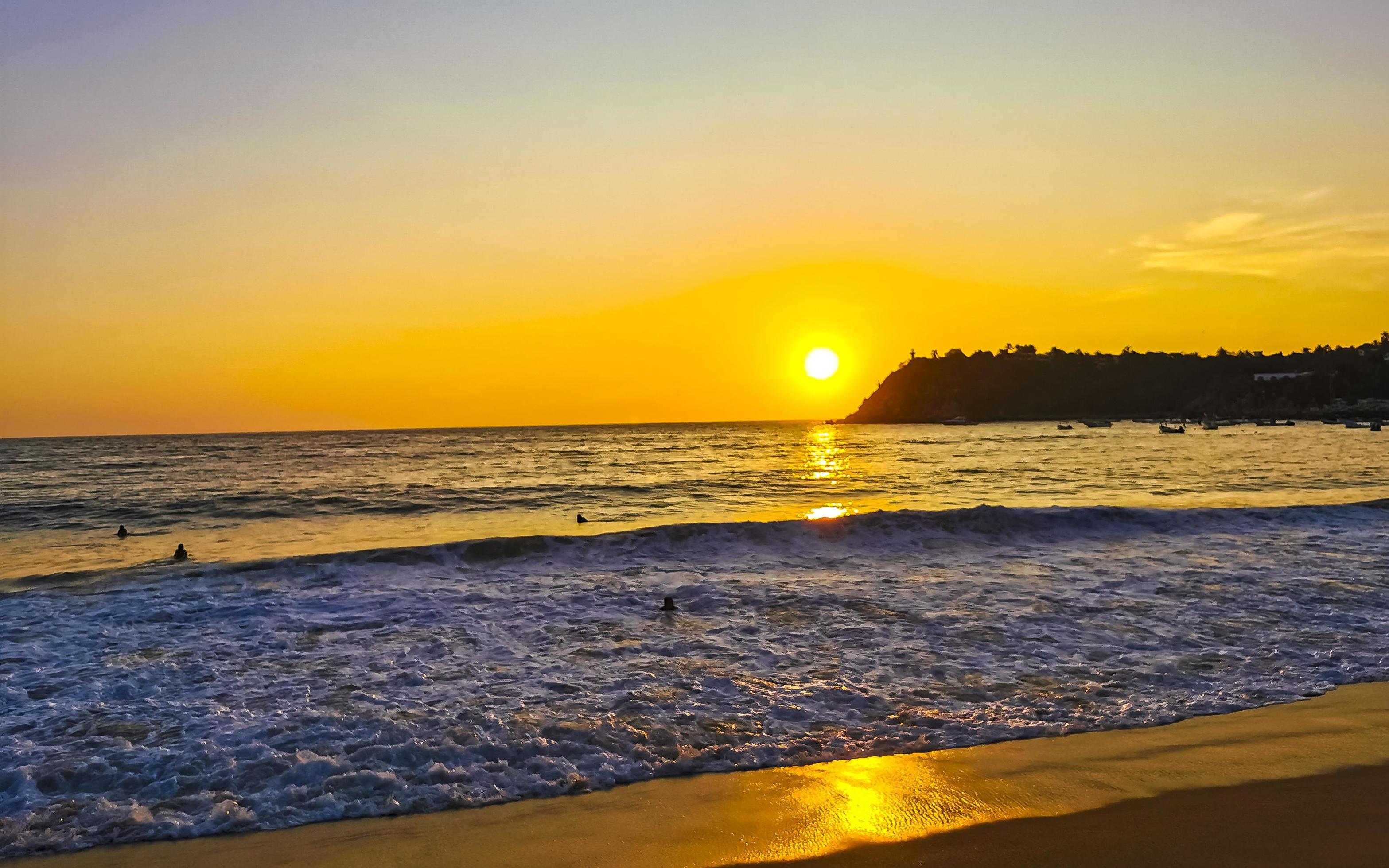 Colorful golden sunset big wave and beach Puerto Escondido Mexico ...