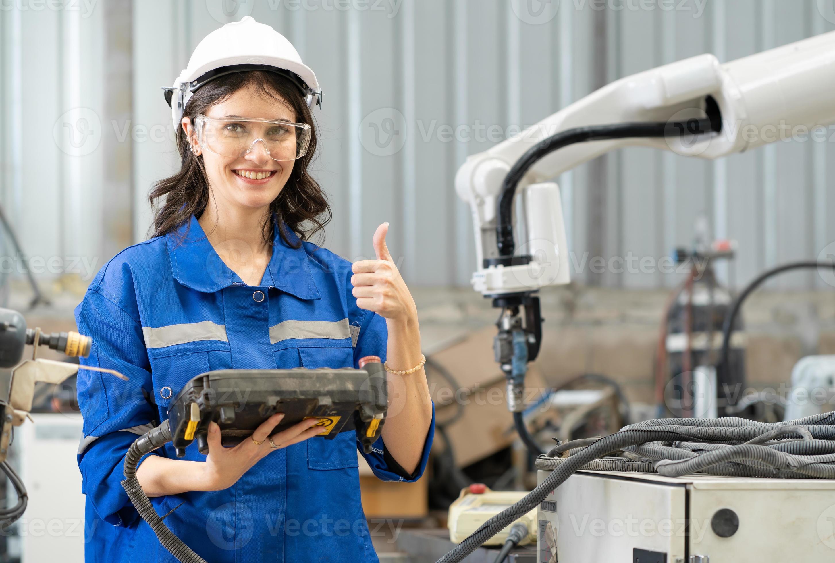 Portrait of female industrial engineer happy working with robotic ...