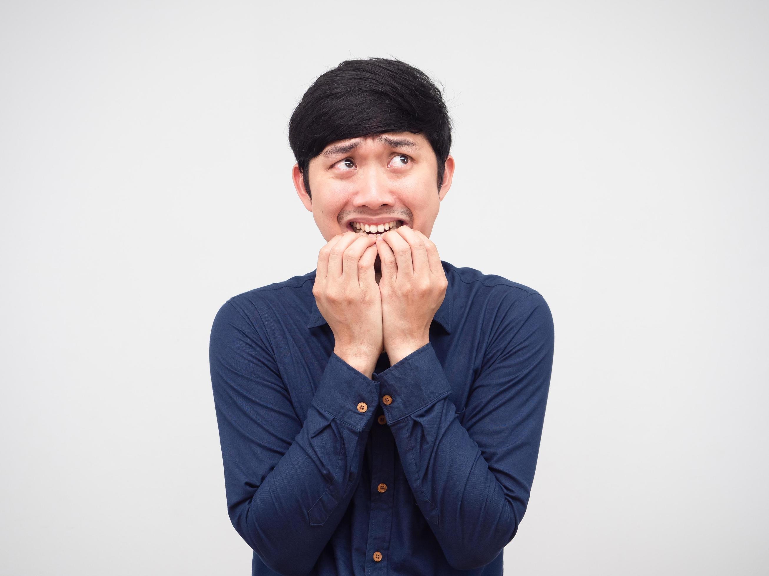 Asian man feeling afraid and bite his hand nail looking up portrait white background 16684410 ...