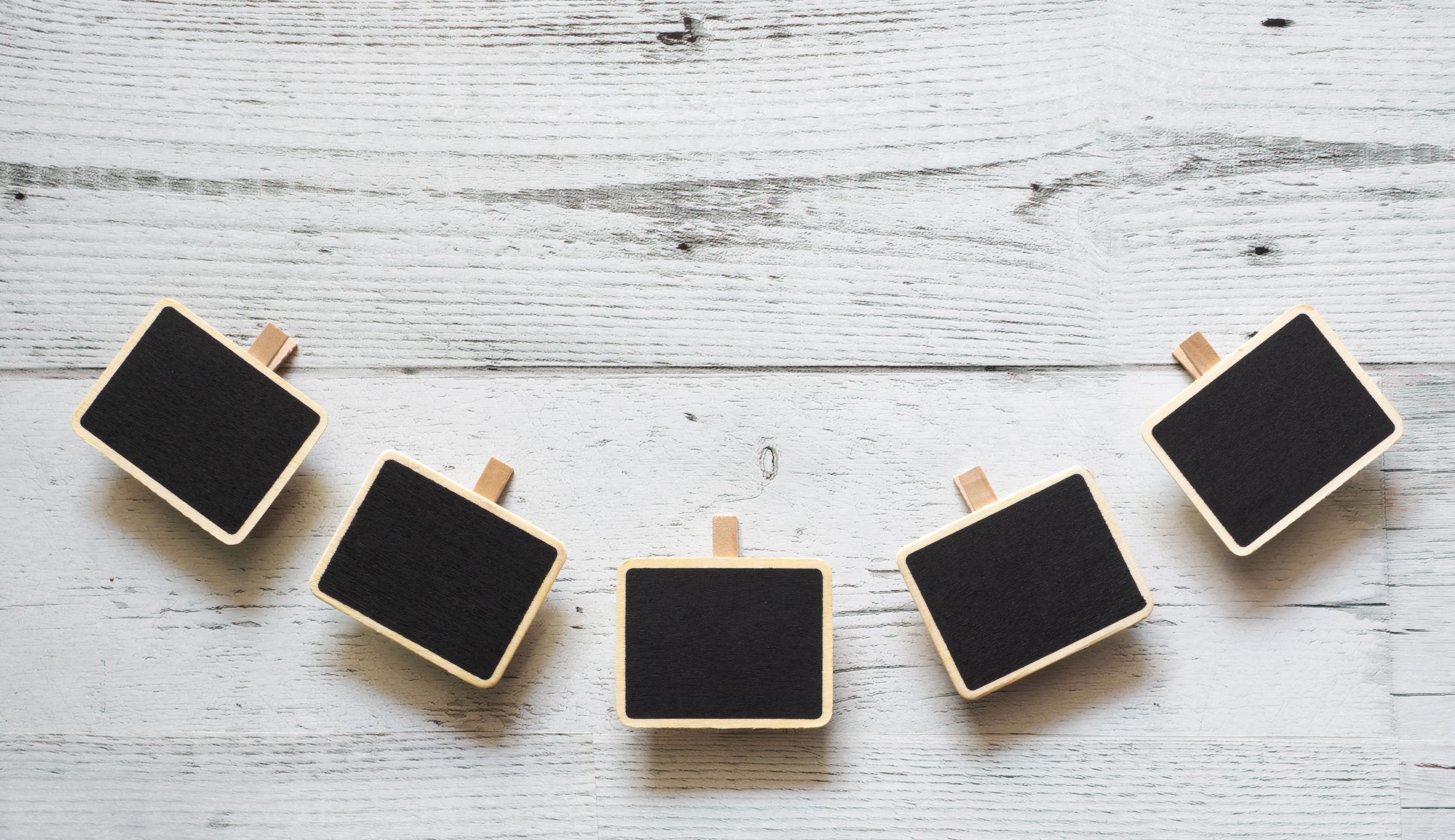 Five small clip chalkboard curve array line on white wood table nature ...