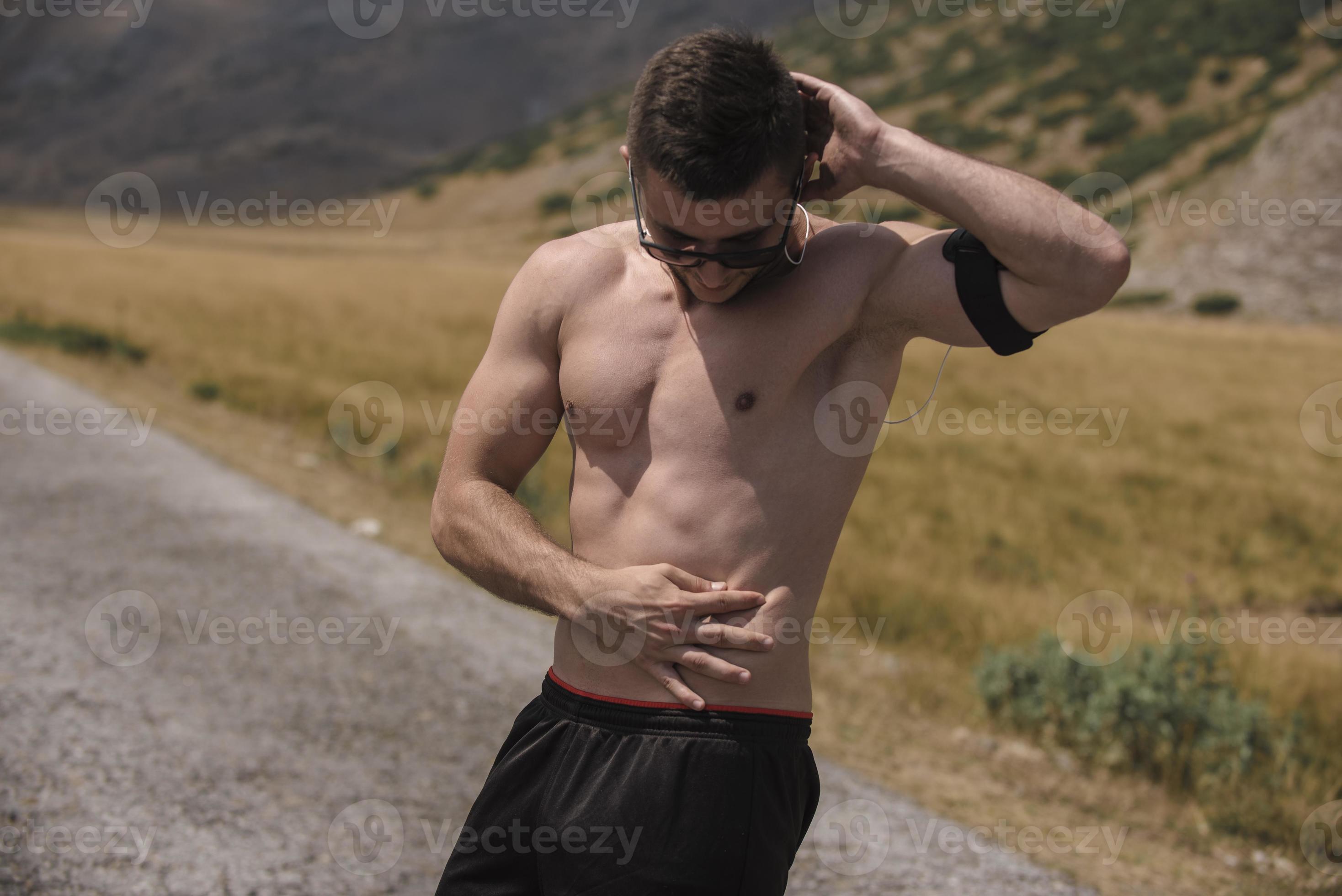 Athletic young man stretching after run in the nature. sport concept 16690438 Stock Photo at ...