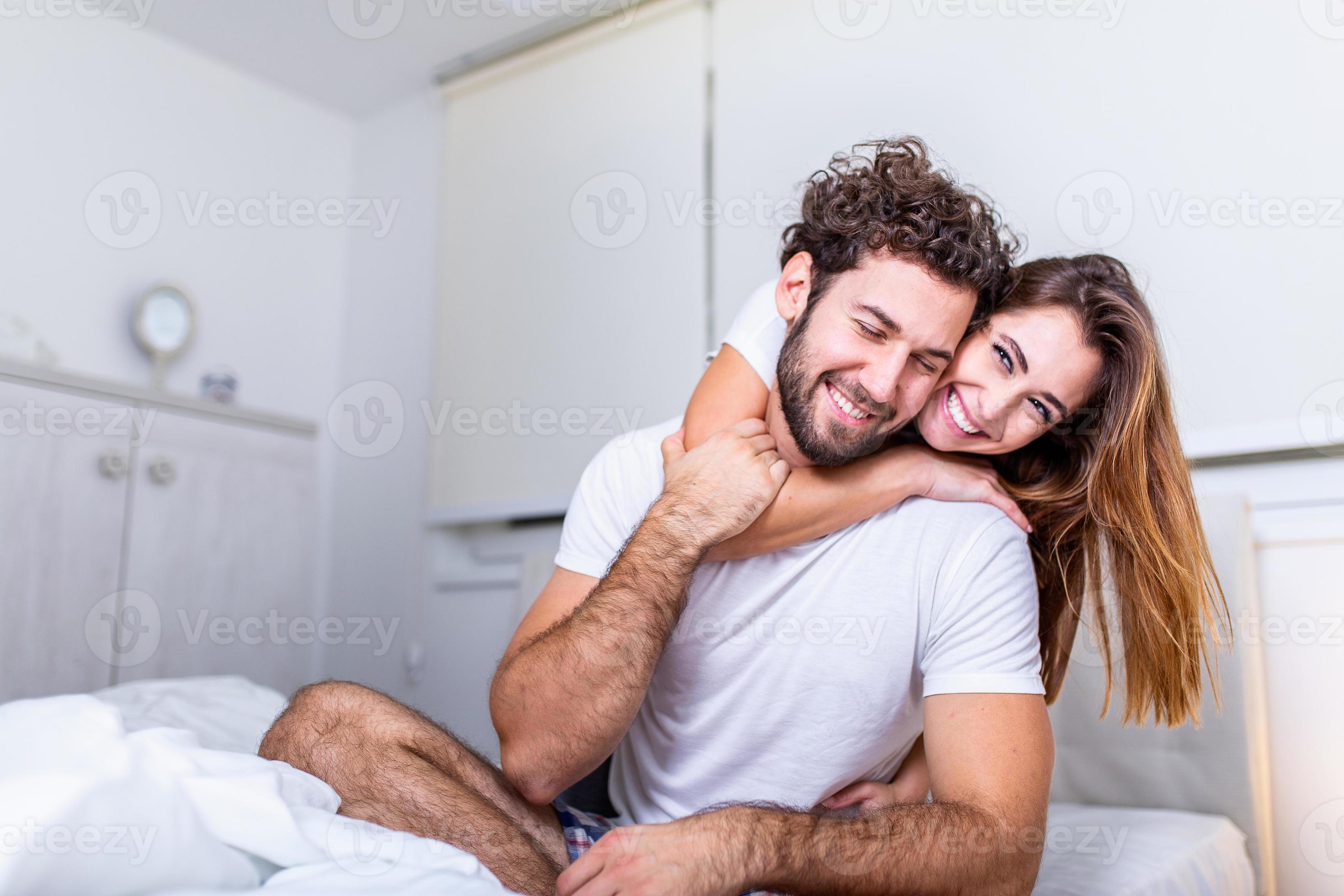 Beautiful Young Couple At Home Hugging Kissing And Enjoying Spending