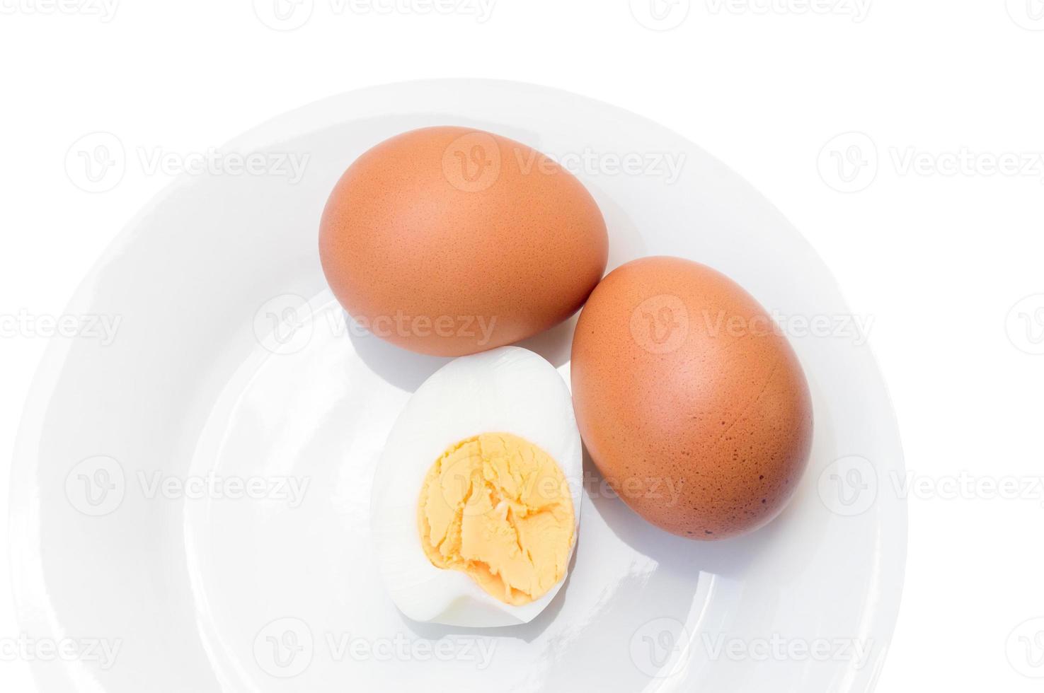 Close Up Of Two Boiled Chicken Eggs With Peeled Half On White Plate Is Isolated On White