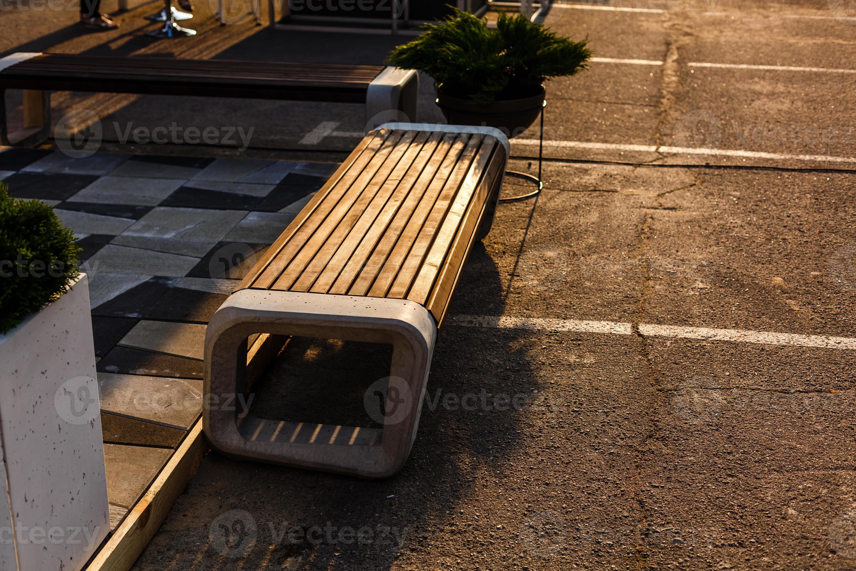 Modern benches in the city square on a sunny day. City improvement, urban planning, public ...
