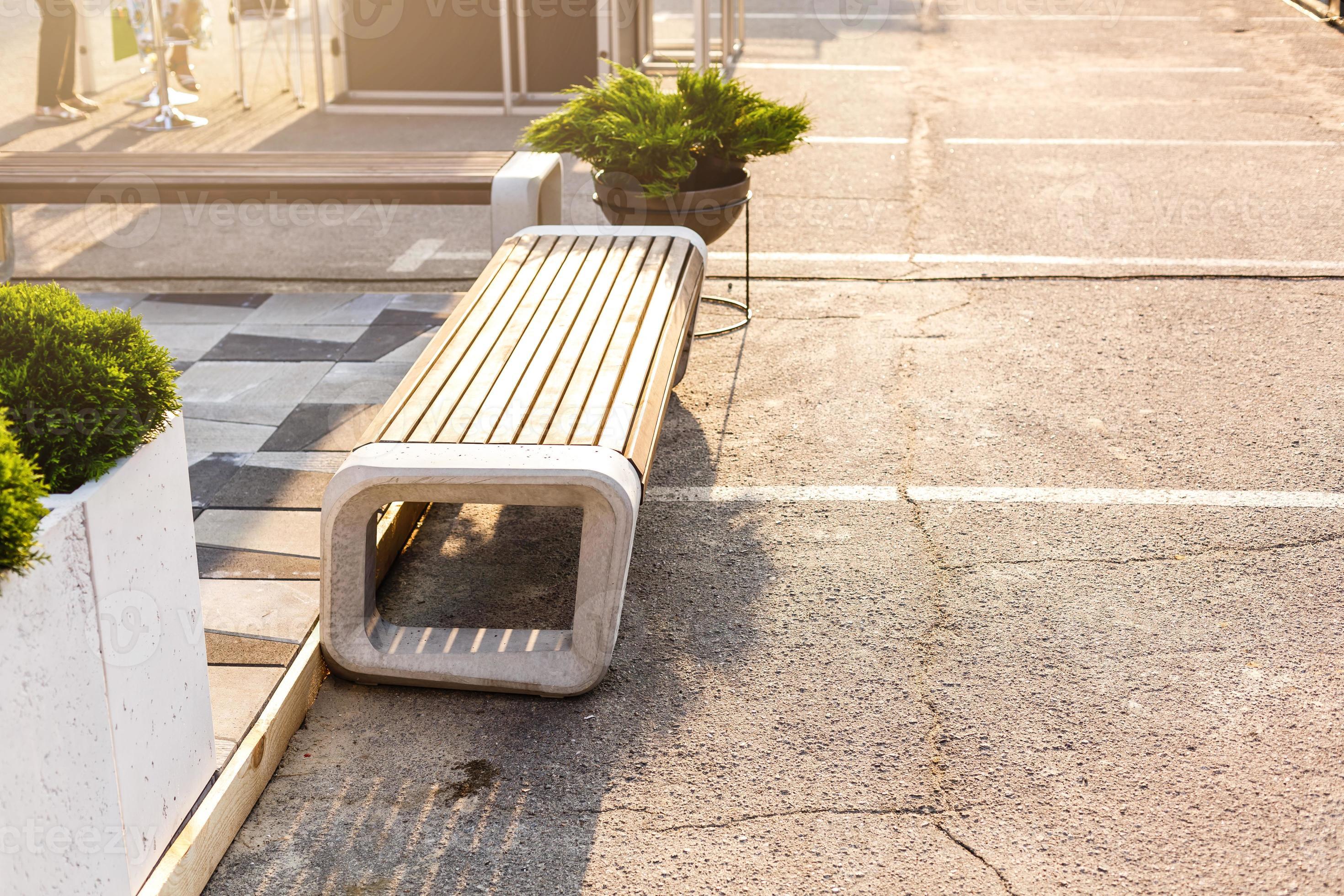 Modern benches in the city square on a sunny day. City improvement, urban planning, public ...