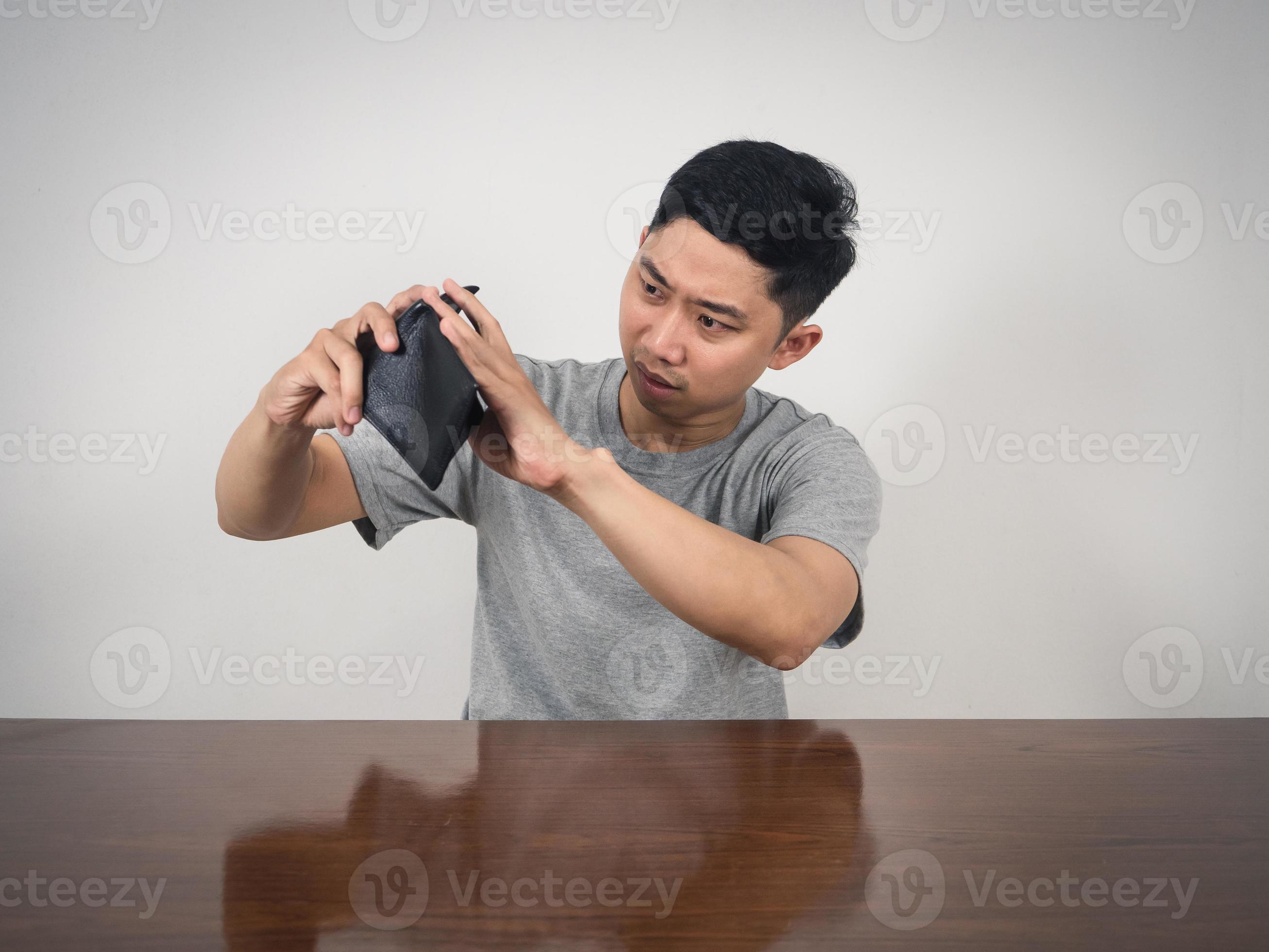 Asian man sitting and shake his wallet for finding money,Poor man 16789865 Stock Photo at Vecteezy