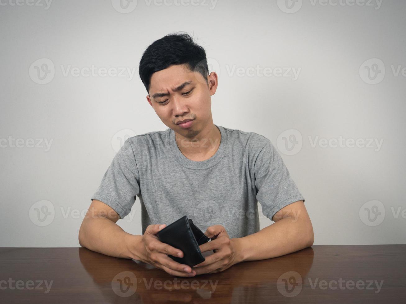 Poor man sitting feels sadness about no money hold empty wallet in hand 16790064 Stock Photo at ...